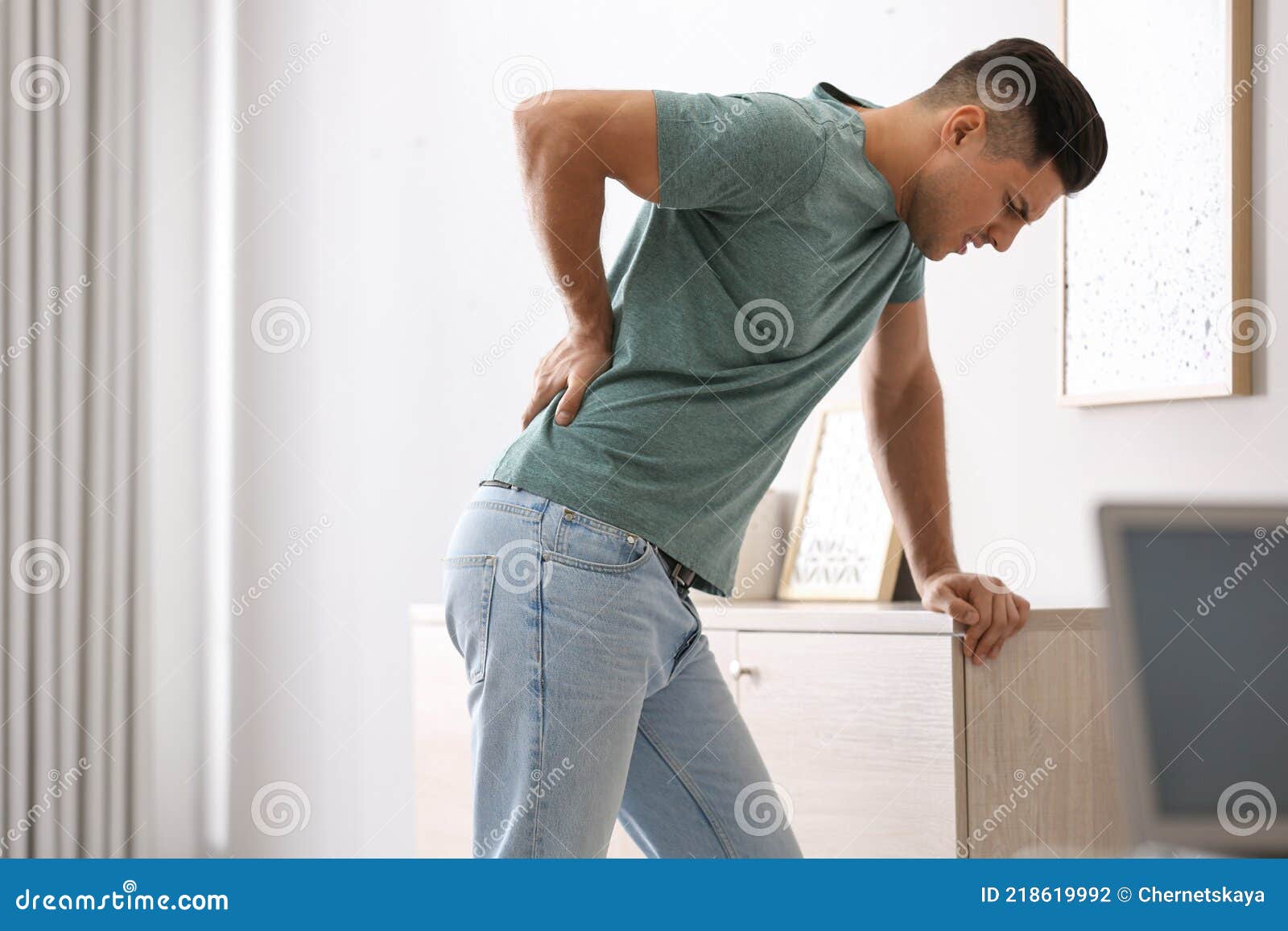 Man Suffering from Back Pain at Home. Bad Posture Problem Stock Photo ...