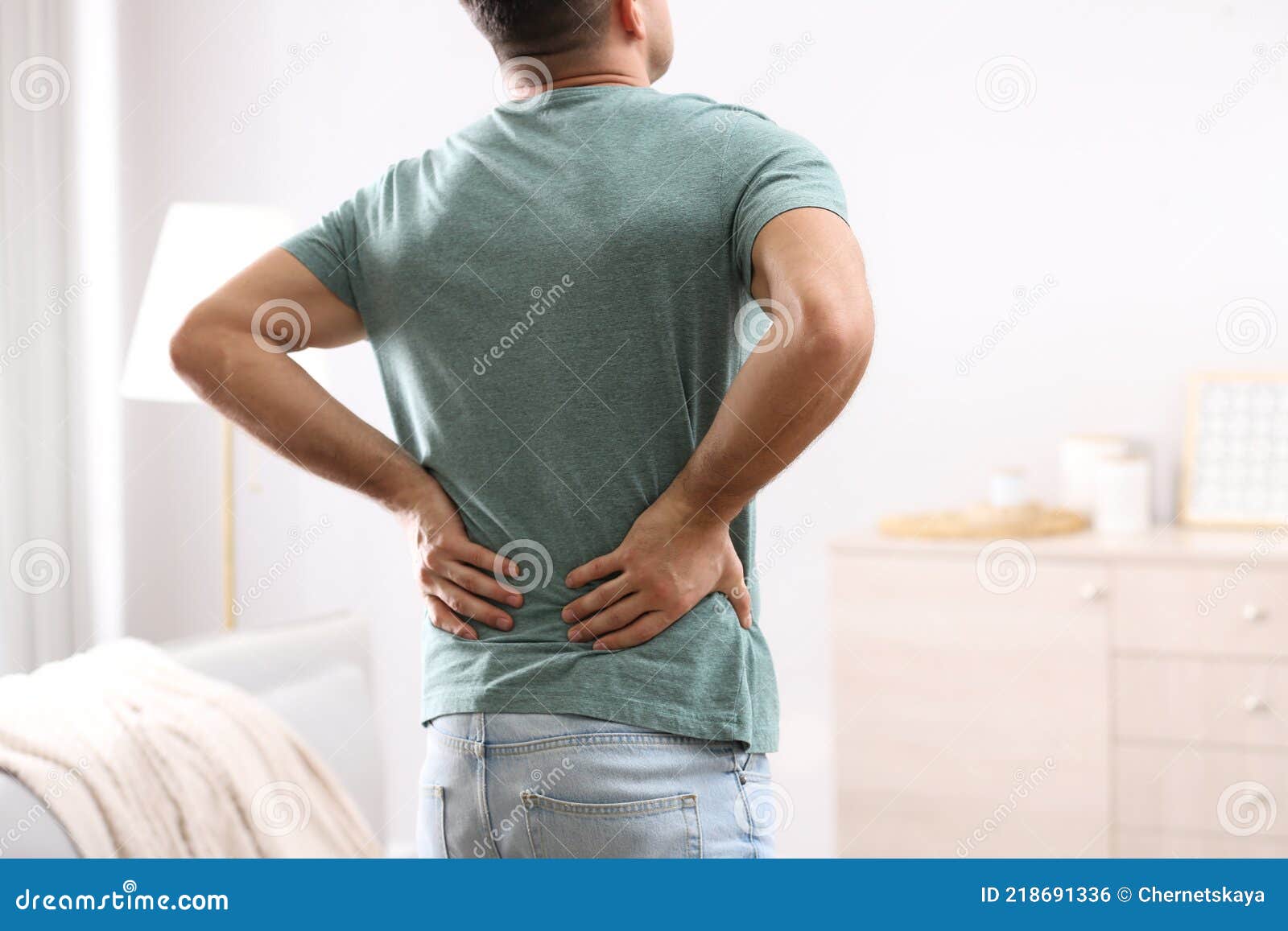 Man Suffering from Back Pain at Home. Bad Posture Problem Stock Photo ...