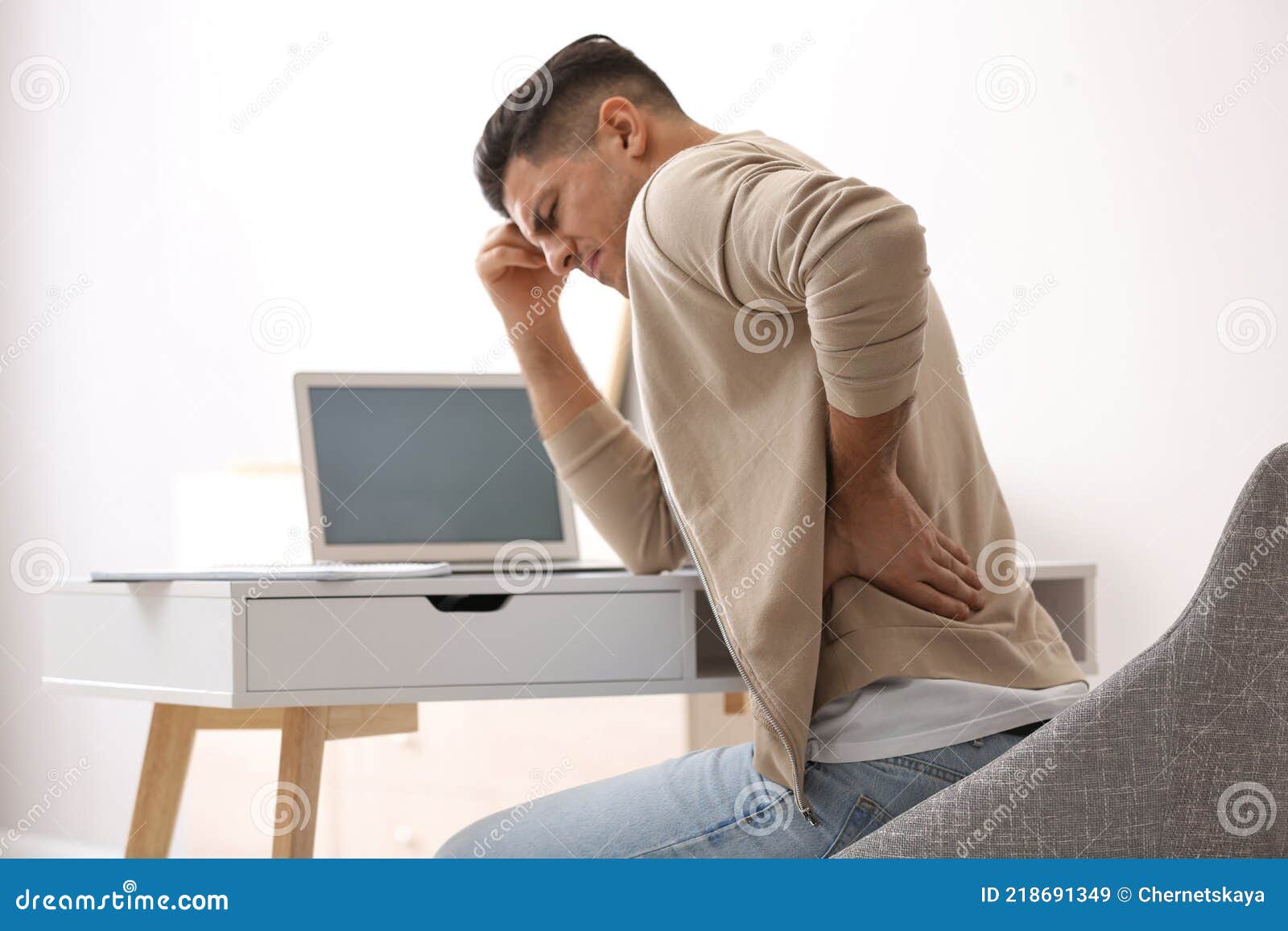 Man Suffering from Back Pain at Workplace. Bad Posture Problem Stock ...