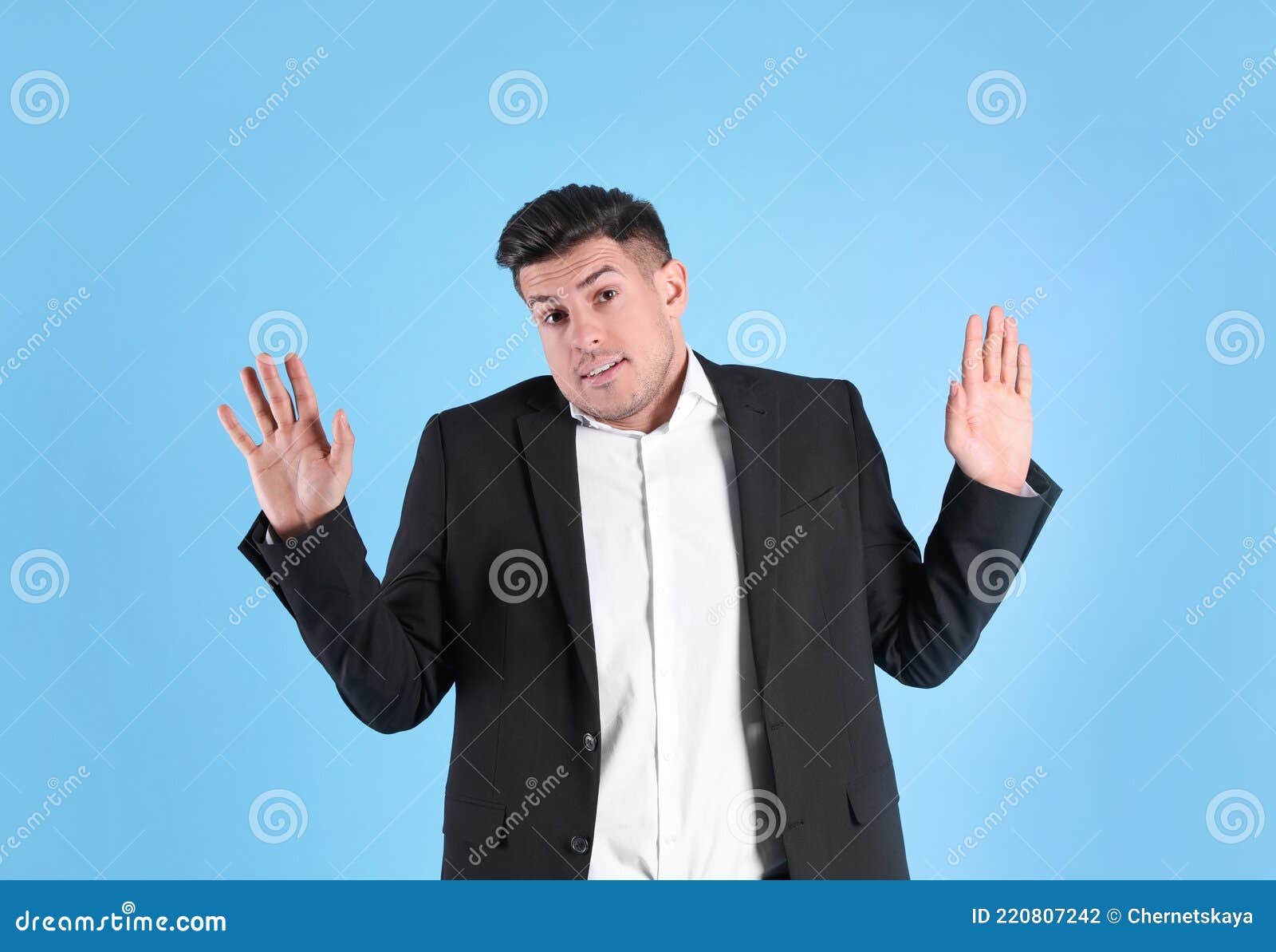 Man in Suit Avoiding Something on Light Blue Background Stock Photo ...
