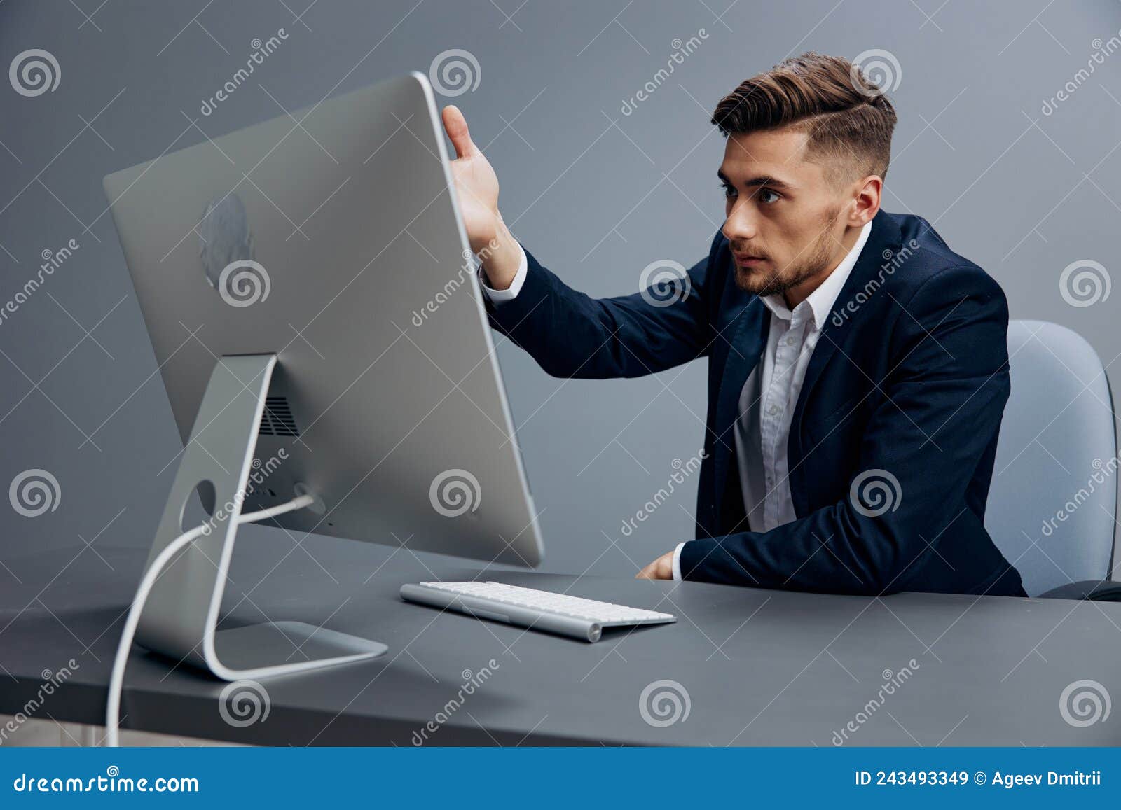 A Man in a Suit Emotions Works in Front of a Computer Executive Stock ...