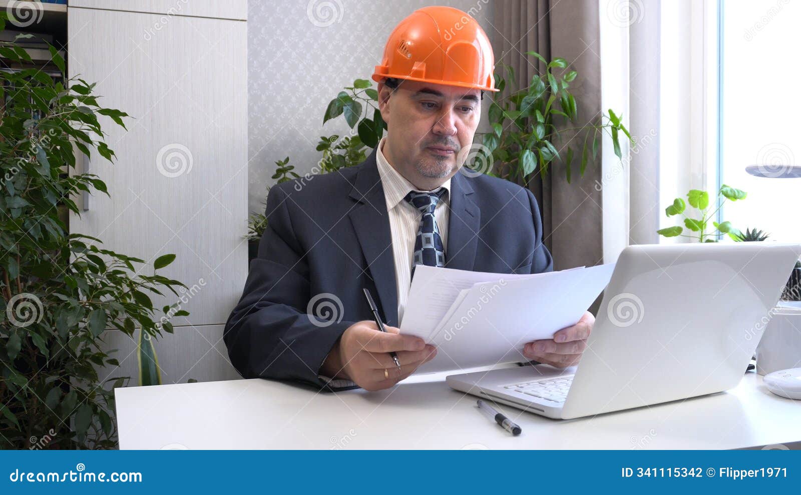 A Man in Suit and Hard Hat Working at His Desk Stock Photo - Image of ...