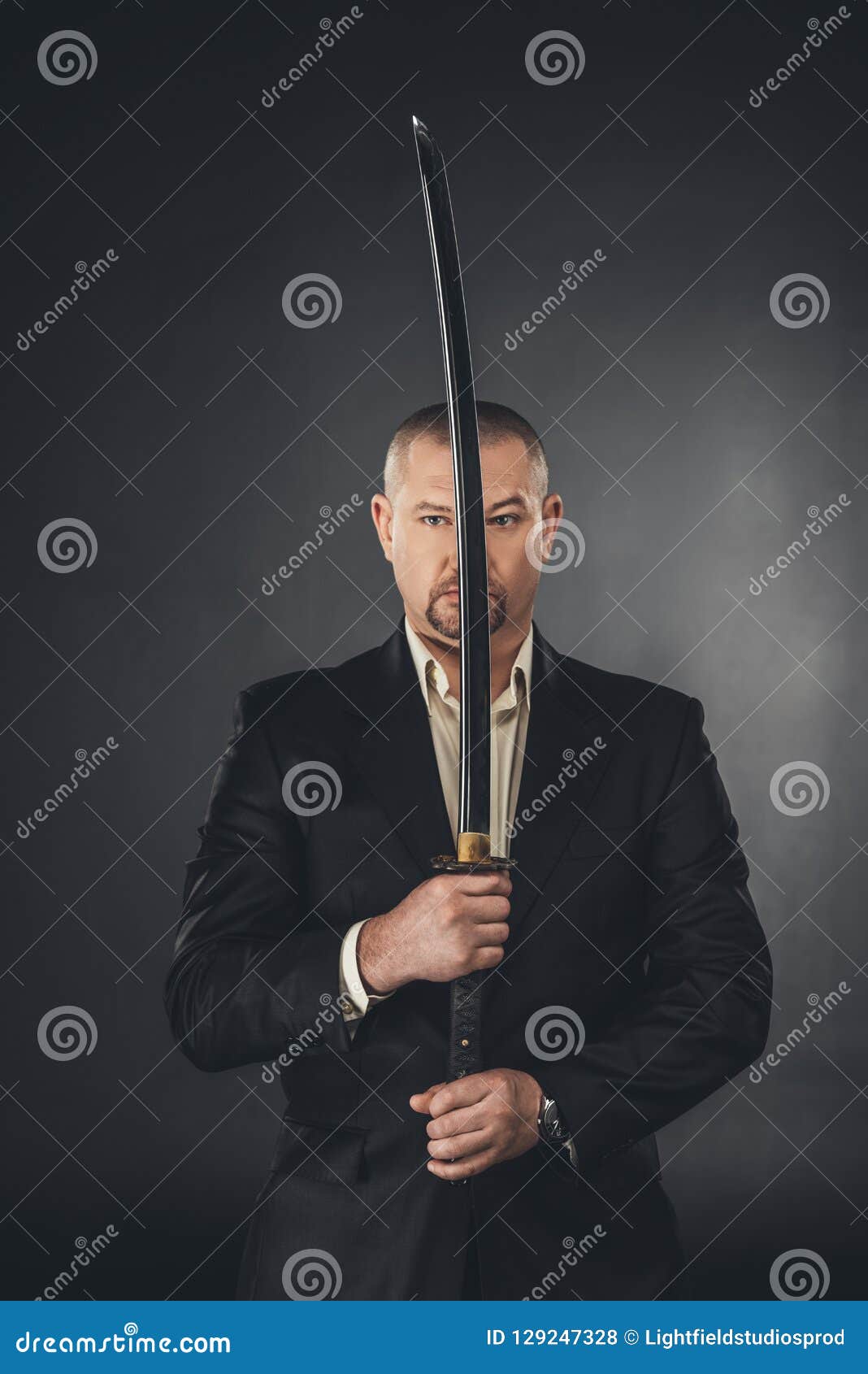 Man in Suit Holding Katana Sword in Front of His Face Stock Photo ...
