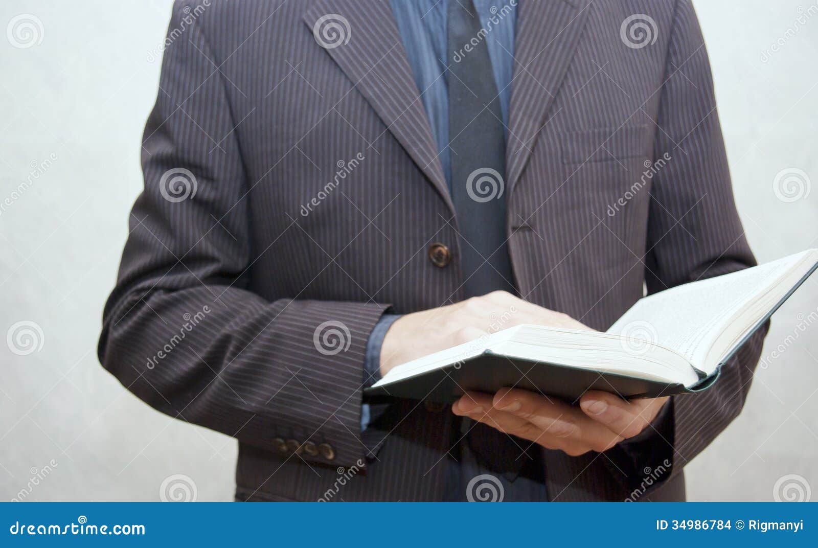 Man in Suit Holding an Open Book Stock Photo - Image of christian ...