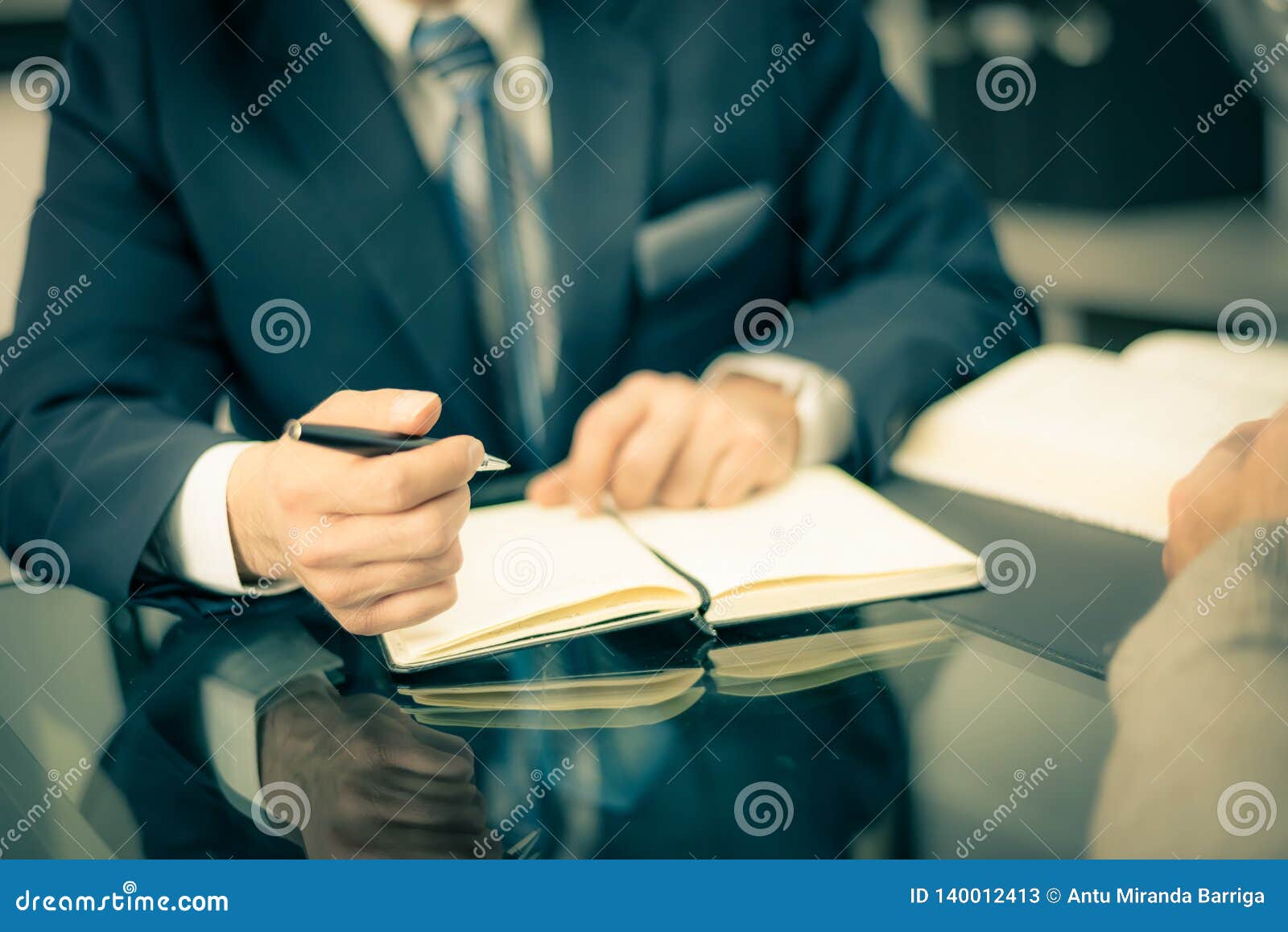 Man in a Suit Holding a Pen and Taking Notes Stock Image - Image of ...