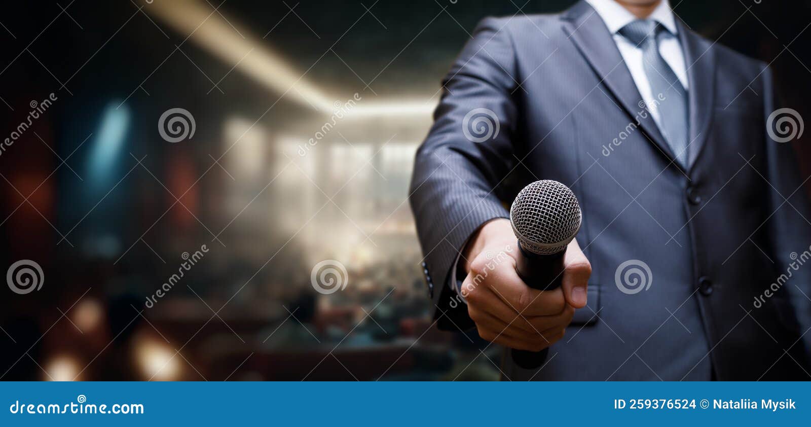 A Man in a Suit Holds Out a Microphone Stock Photo - Image of ...