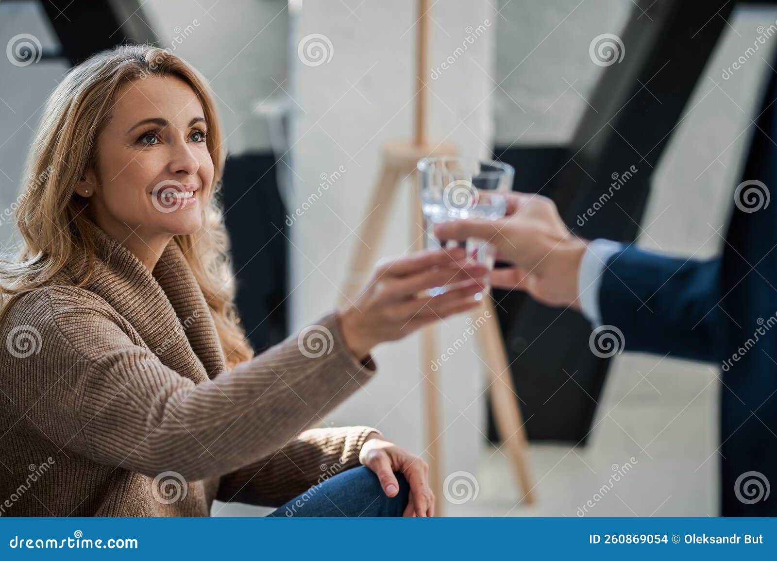 Man in a Suit Offering a Glass of Water To the Client Stock Photo ...