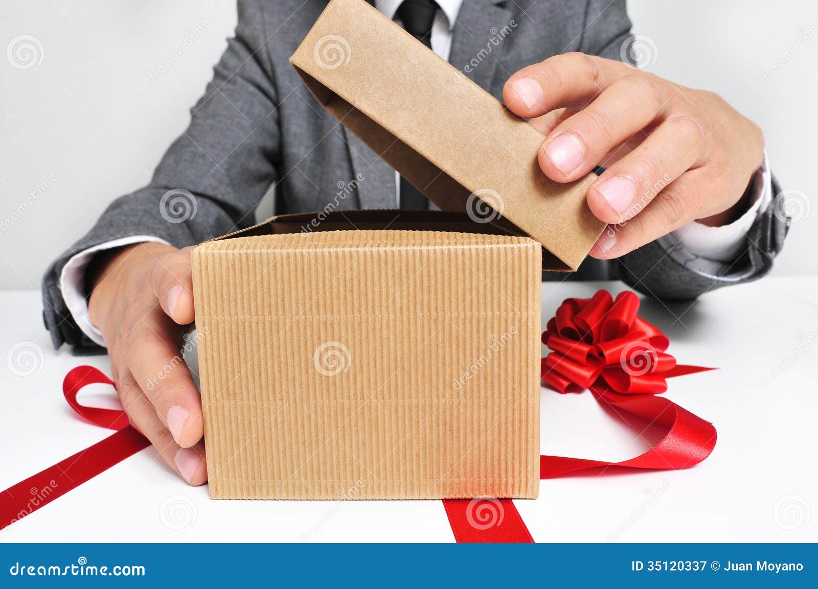 Man in suit opening a gift stock image. Image of fathers - 35120337
