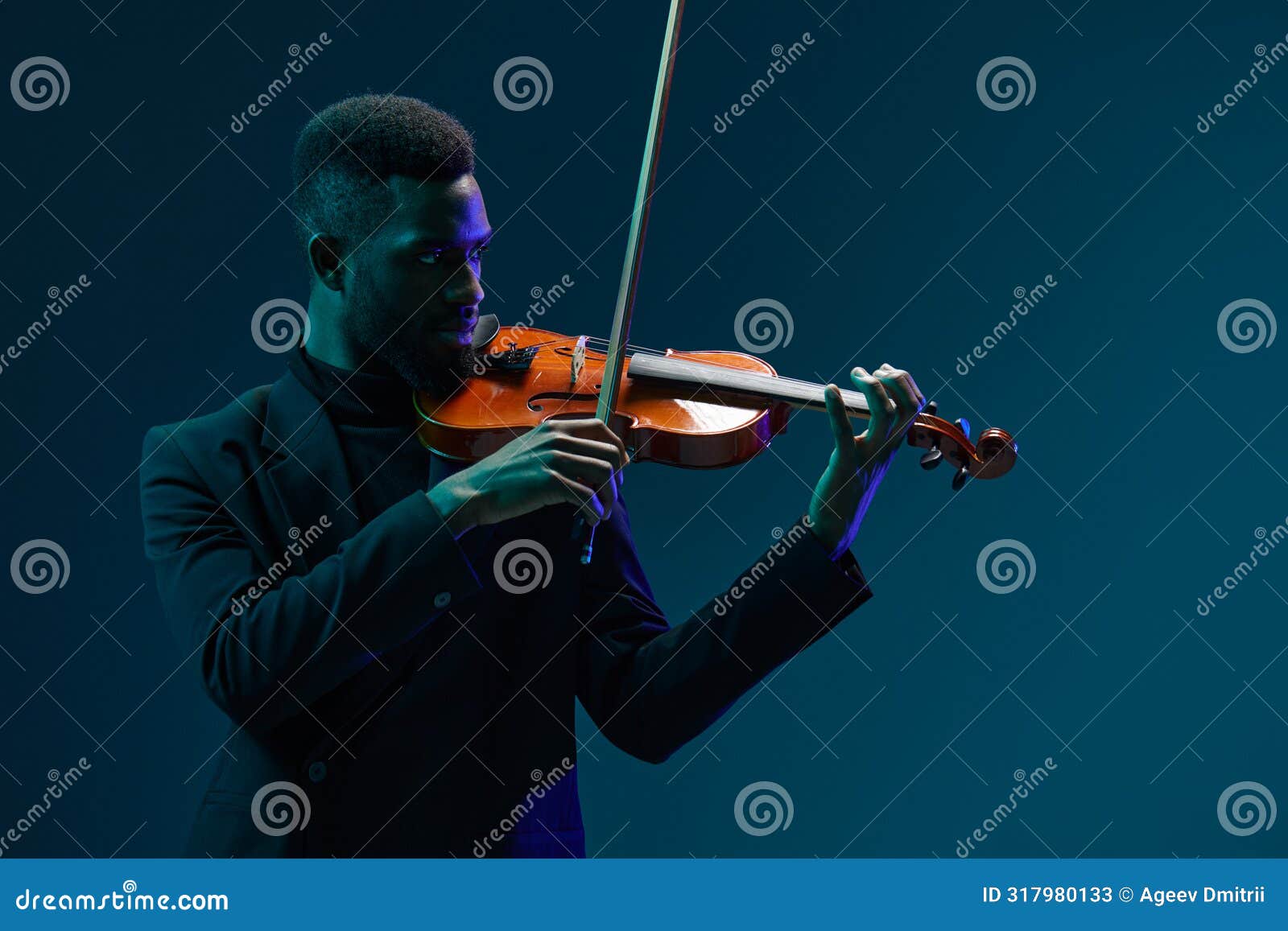 Man in Suit Playing Violin in Dramatic Lighting Against Dark Background ...