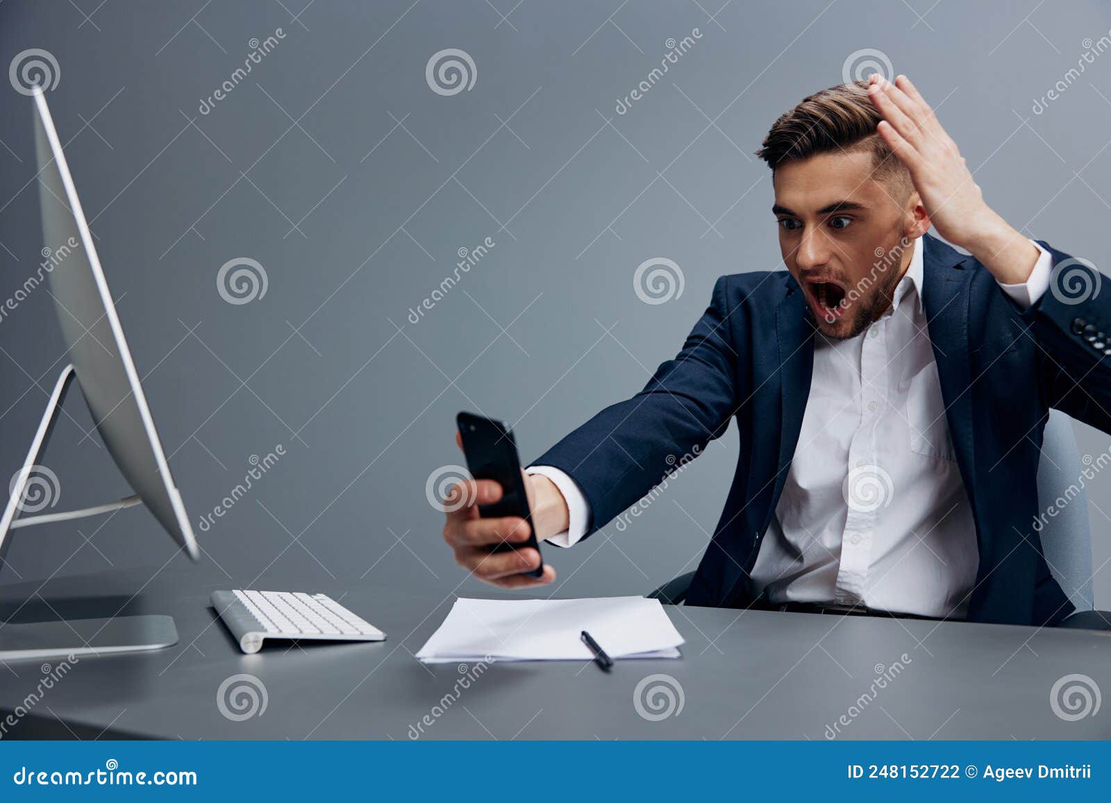 A Man in a Suit Problems at Work Sitting at a Desk in Front of a ...