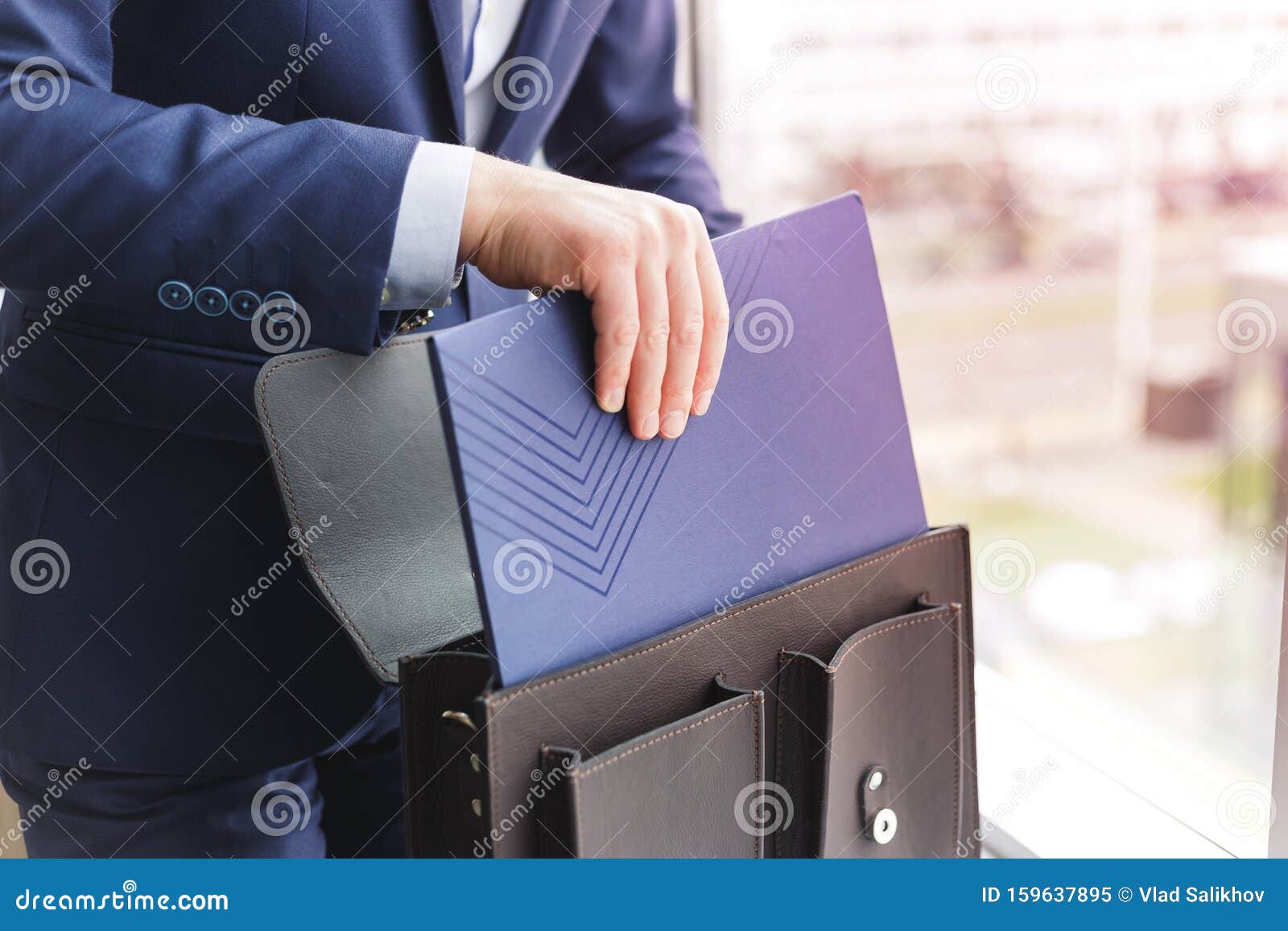 Man in Suit Puts Folder with Docs into Briefcase Stock Image - Image of ...