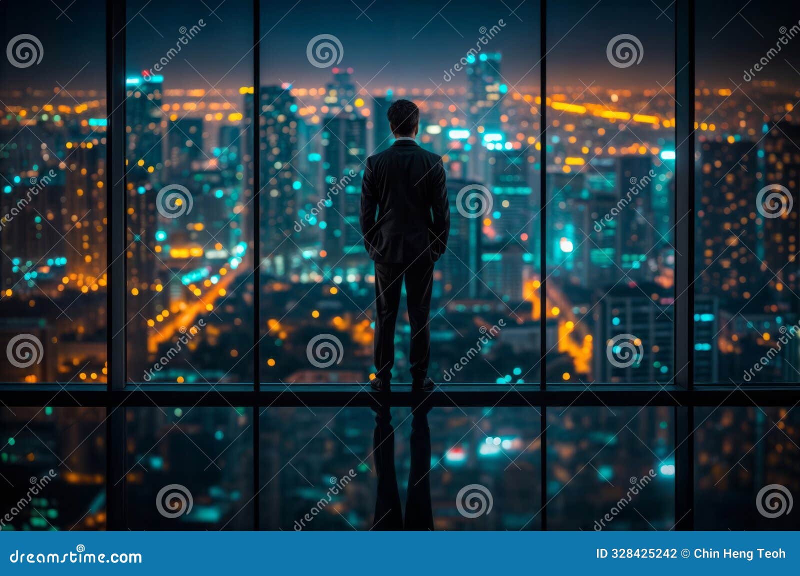 A Man in a Suit Standing by a Large Window, Overlooking a Brightly Lit ...