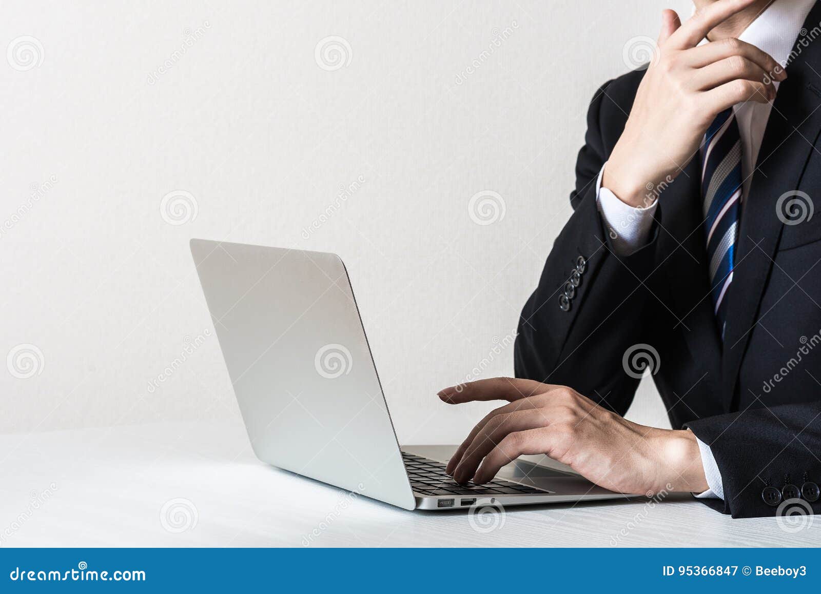 A Man in a Suit Watching a PC Stock Image - Image of estate, business ...