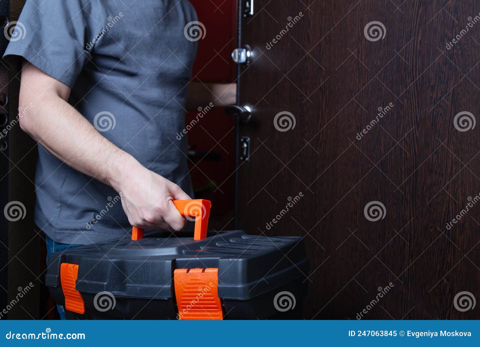 Man with a Suitcase of Tools Coming in Client Home. Repairman or ...