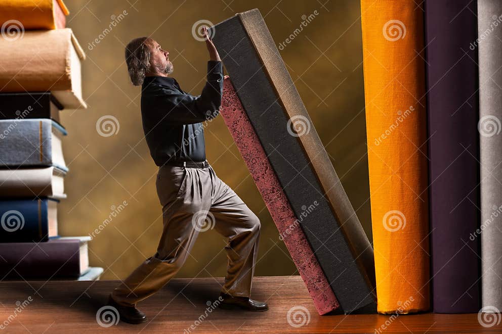 Man Supporting Falling Book in the Bookshelf Stock Image - Image of ...