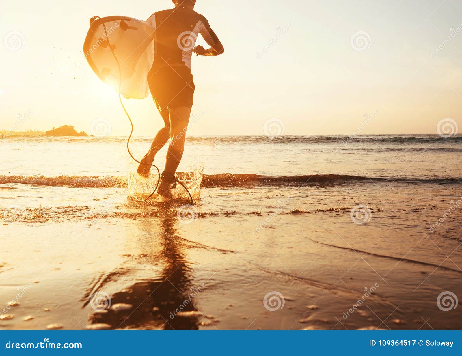 Man Surfer Run in Ocean with Surfboard in Sunset Light Stock Image ...
