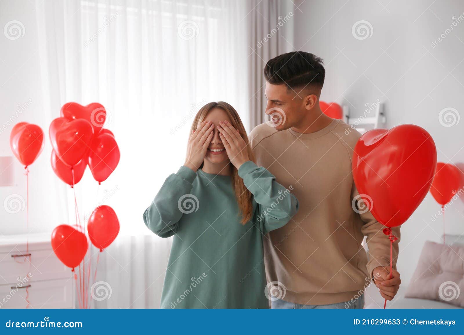 Man Surprising His Girlfriend With Heart Shaped Balloon Indoors