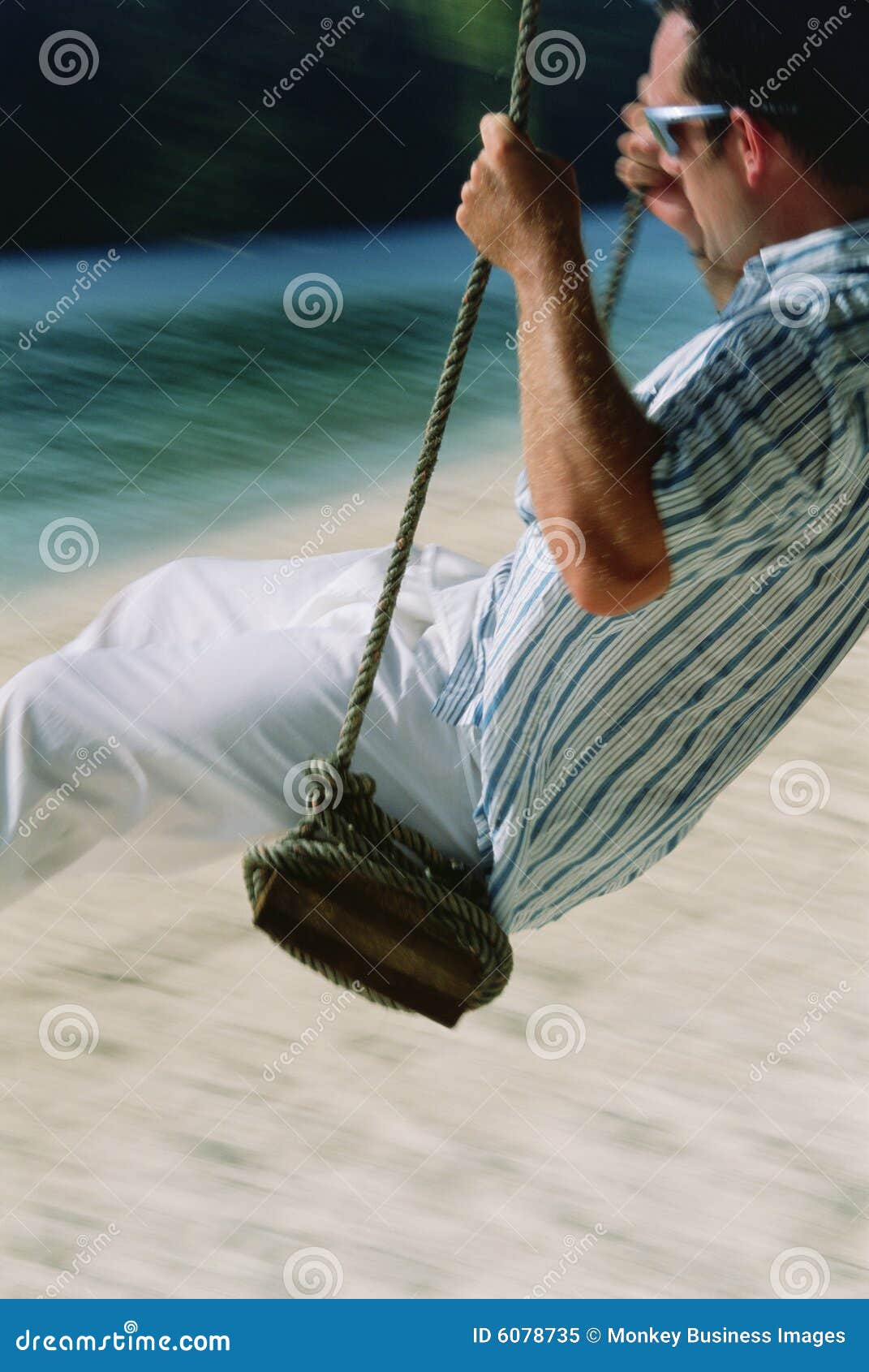 Man on swing at beach stock image. Image of adult, vacation - 6078735