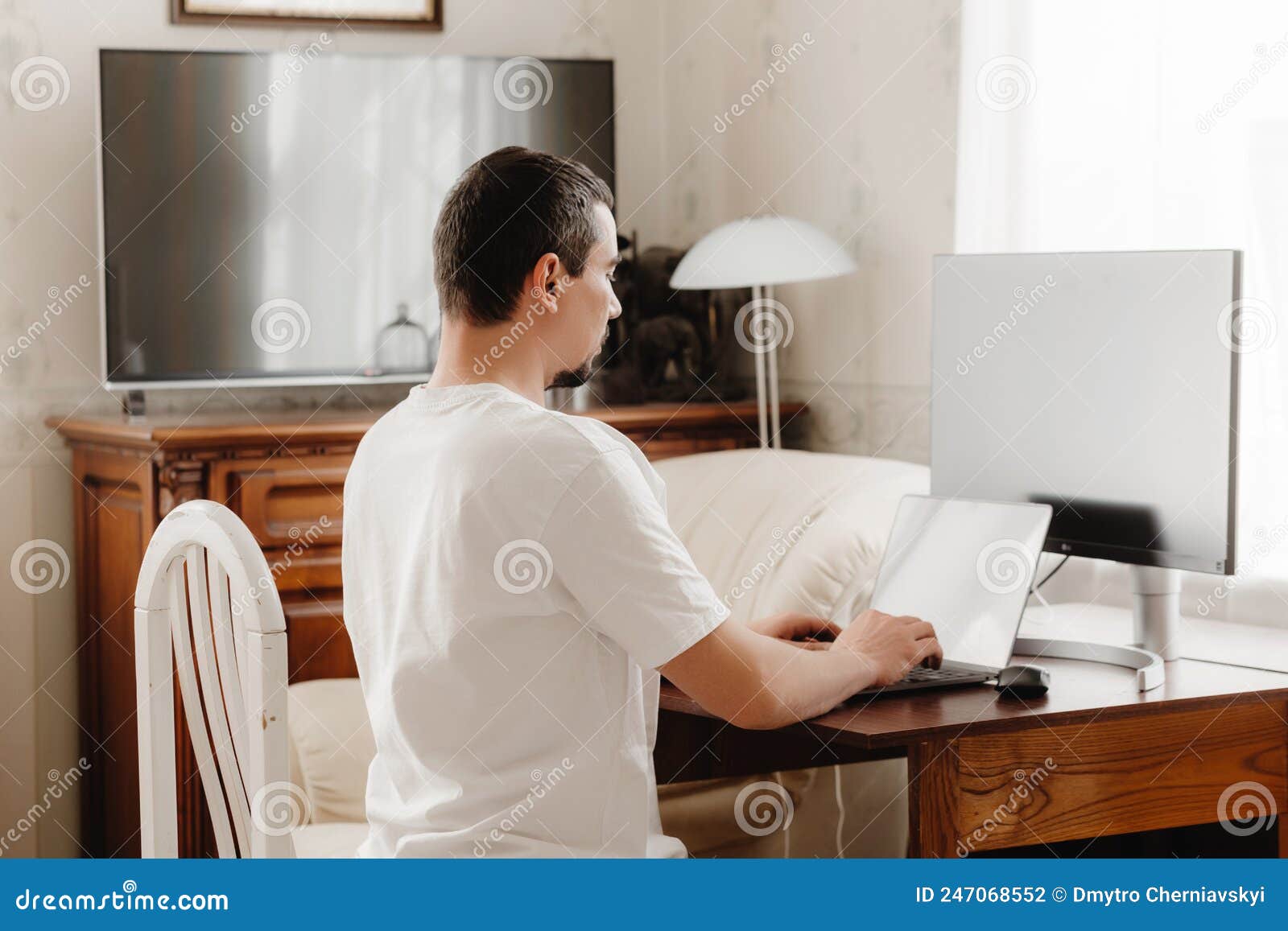 A Man at a Table with Correct Posture Sits at a Computer Stock Photo ...