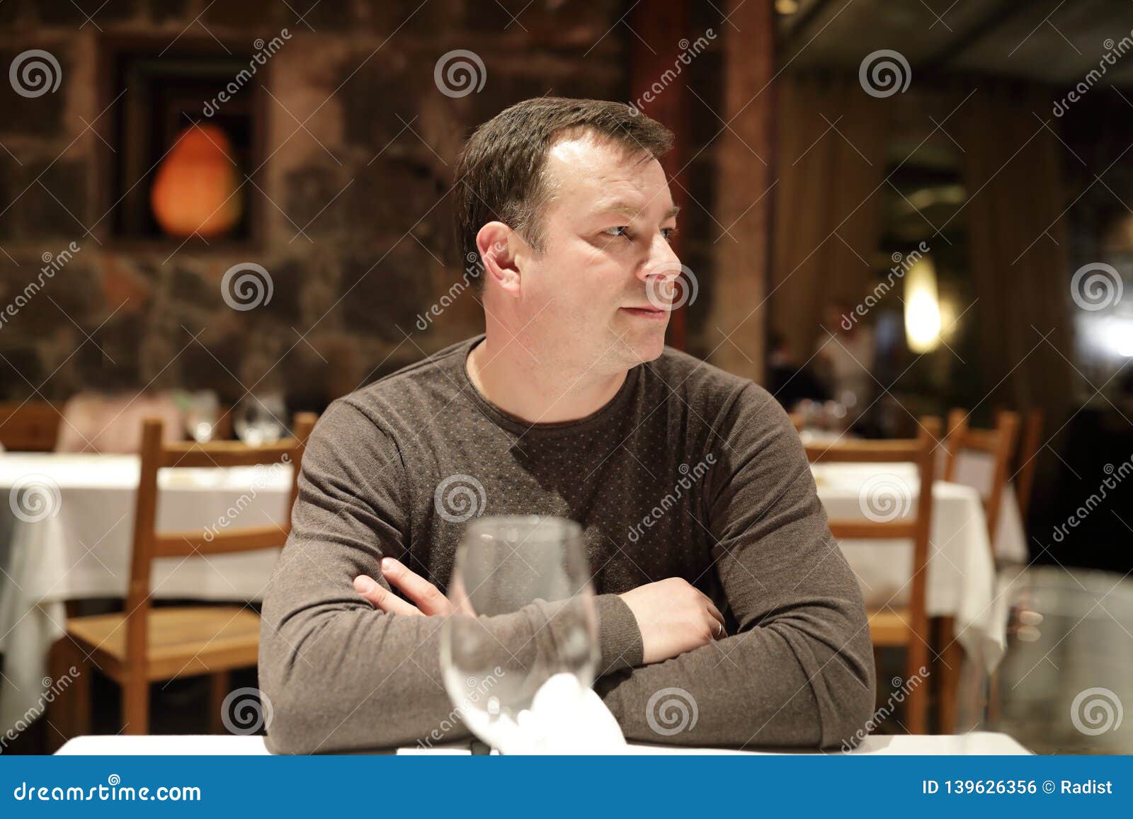 Man at table in restaurant stock photo. Image of lunch - 139626356