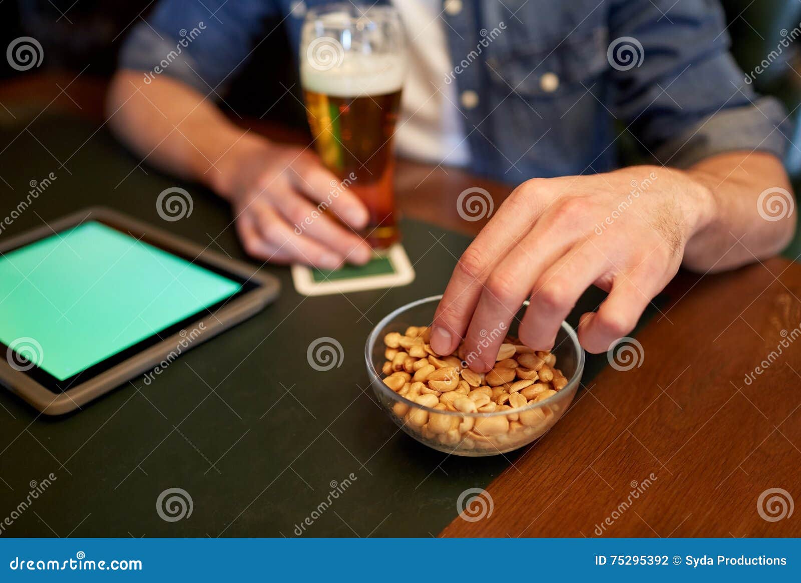 Man with Tablet Pc, Beer and Peanuts at Bar or Pub Stock Photo - Image ...