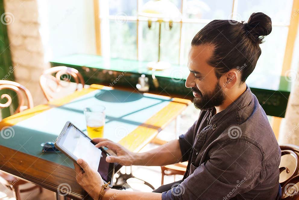 Man with Tablet Pc Drinking Beer at Bar or Pub Stock Photo - Image of ...