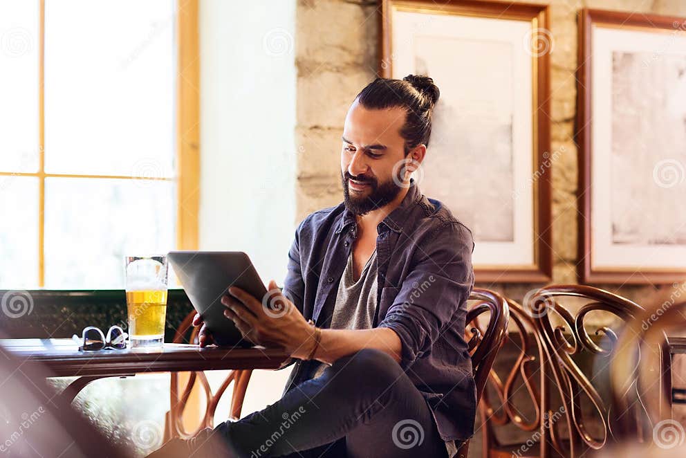 Man with Tablet Pc Drinking Beer at Bar or Pub Stock Photo - Image of ...