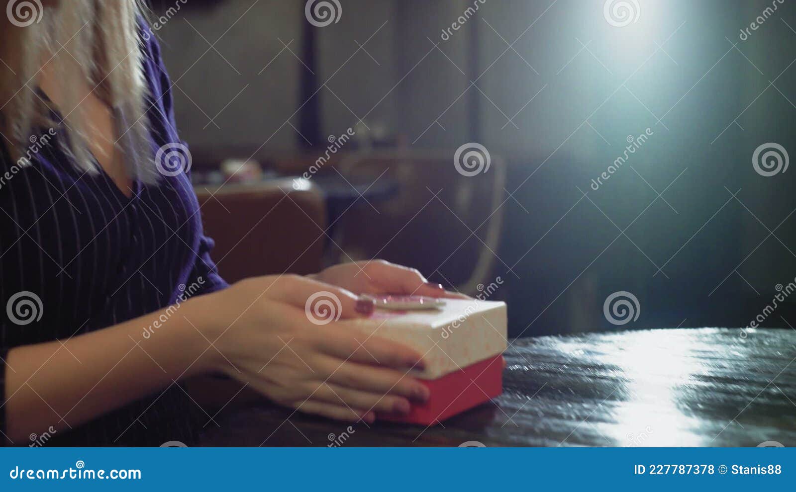 A Man Takes a Gift Box from Under the Table and Puts it on the Table in ...