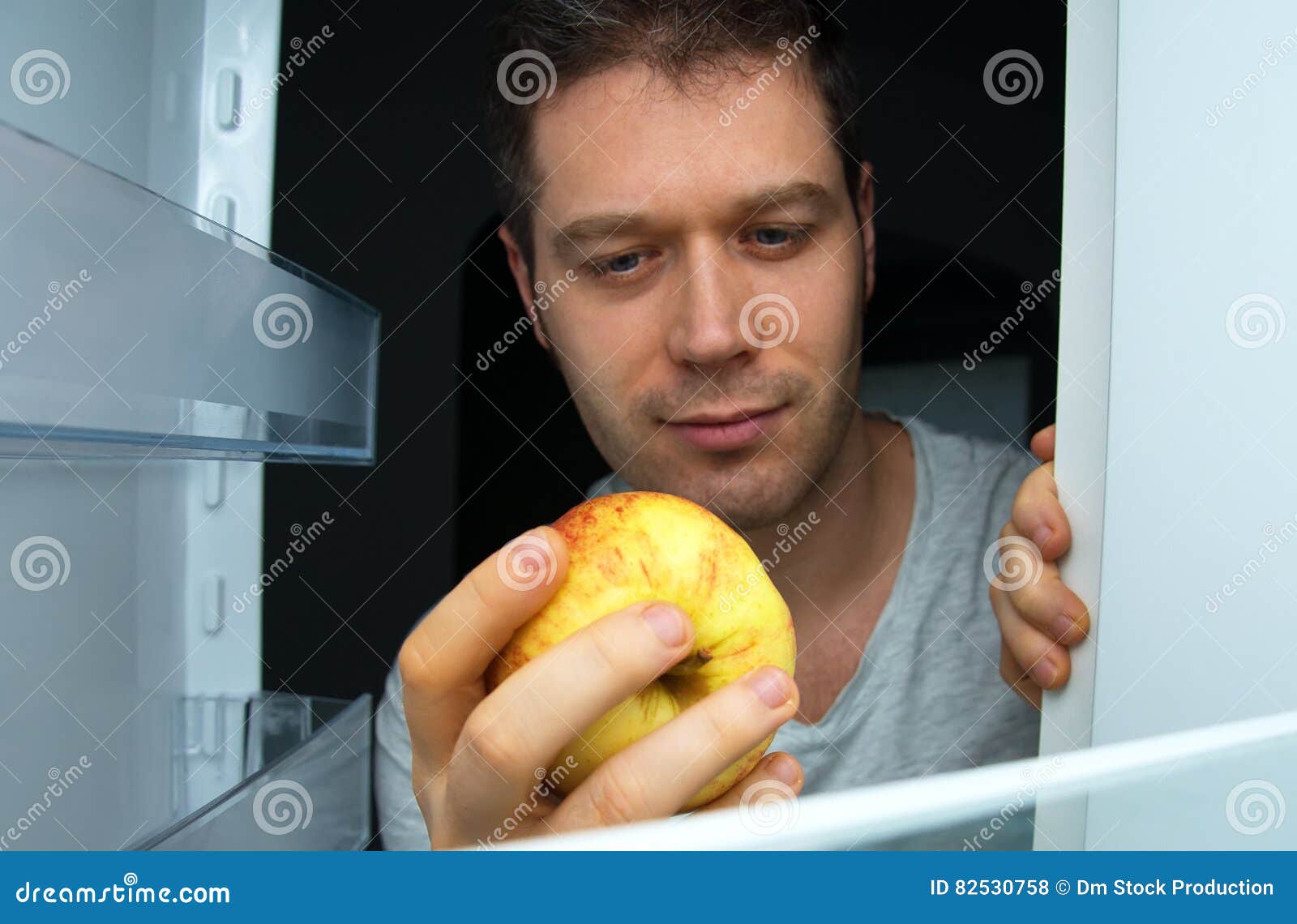 Man taking apple. stock photo. Image of male, food, fridge - 82530758