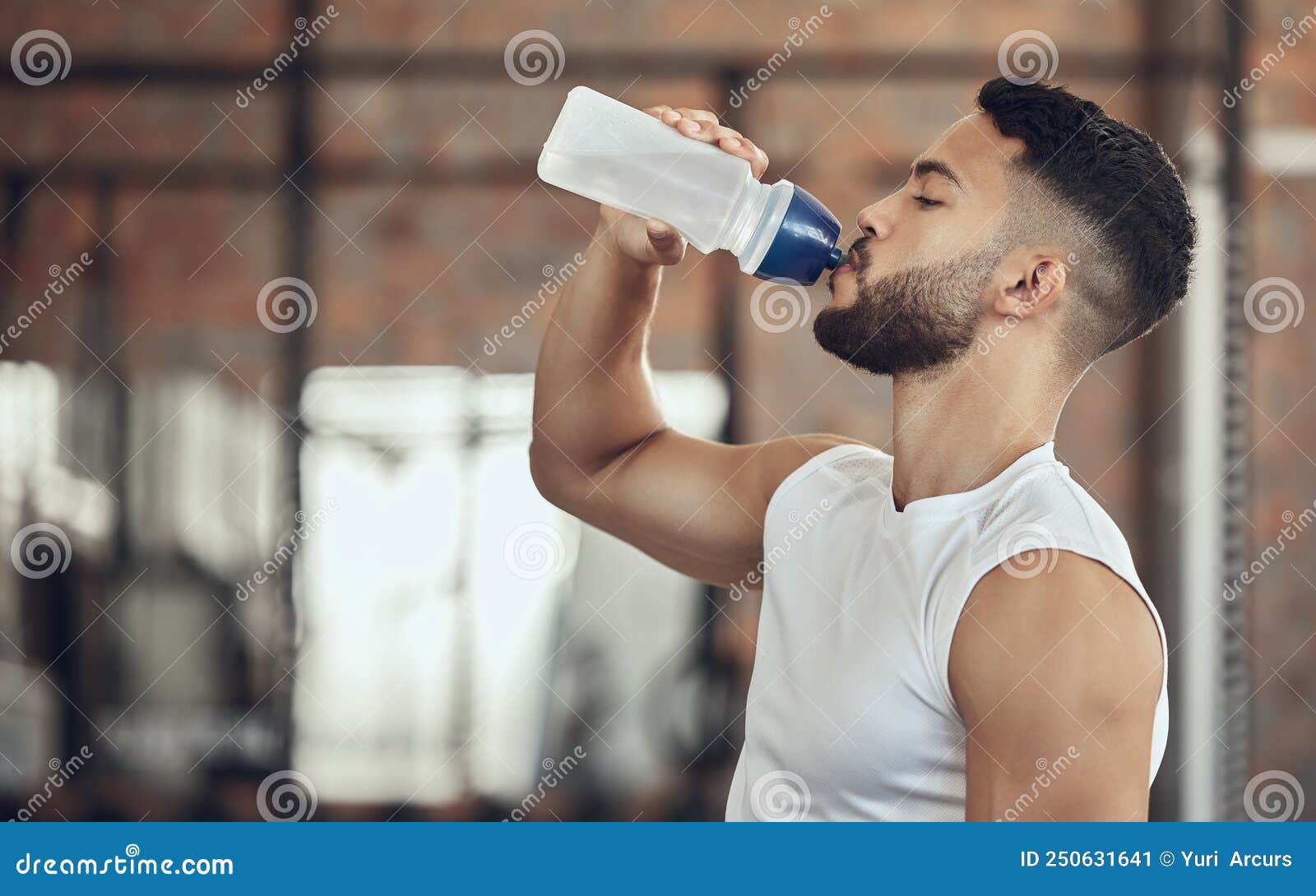 Man Taking a Break from Exercise To Hydrate.Young Man Drinking Water ...