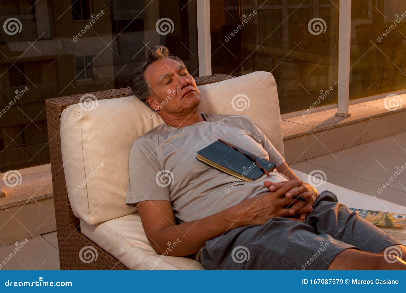 Man taking a napping stock image. Image of reading, balcony - 167087579
