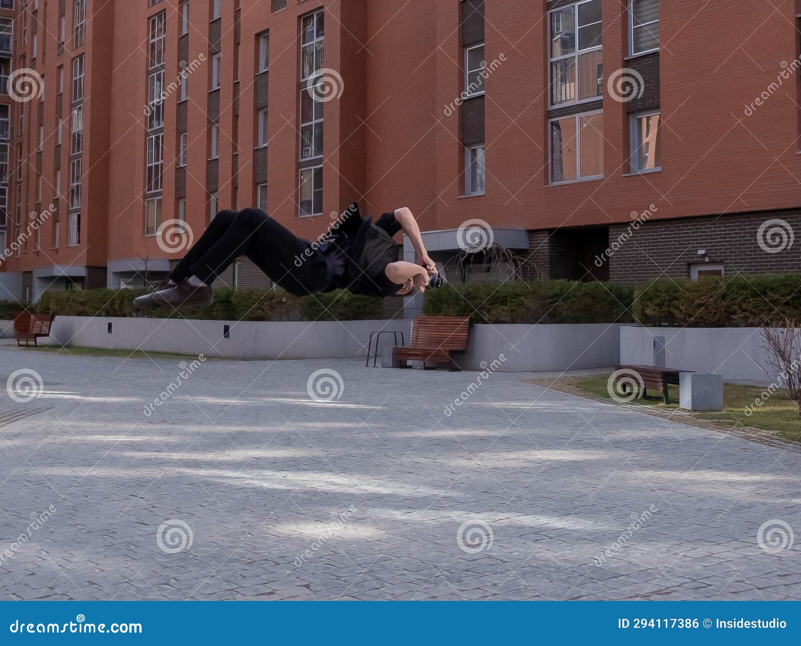 Man Taking Photos while Doing Somersault Outdoors. Stock Photo - Image ...