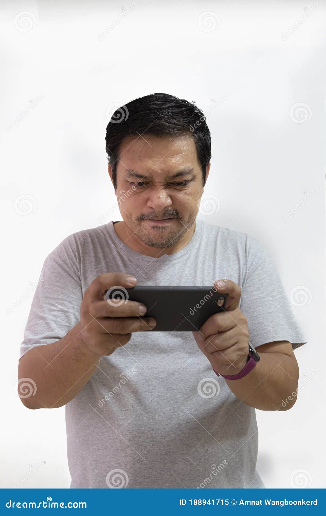 Man is Taking a Serious Pose while Looking at the Mobile Stock Image ...