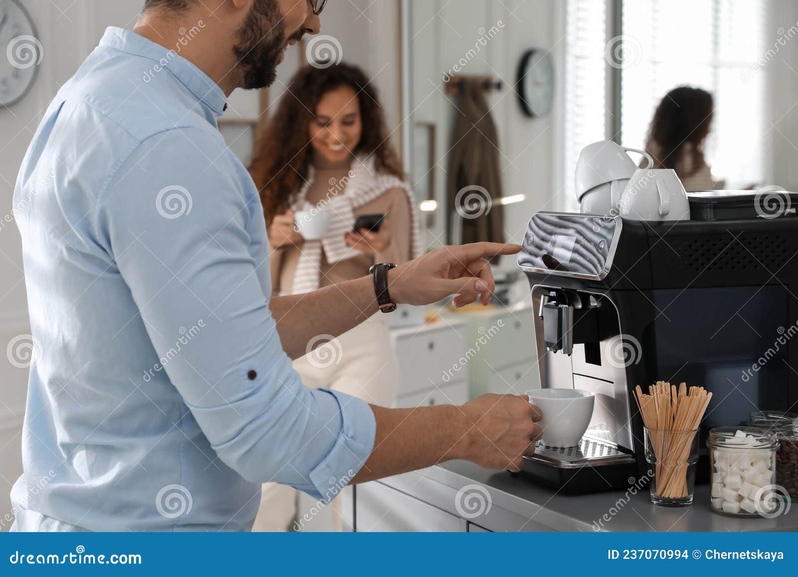 Man Talking with Colleague while Using Modern Coffee Machine in Office ...