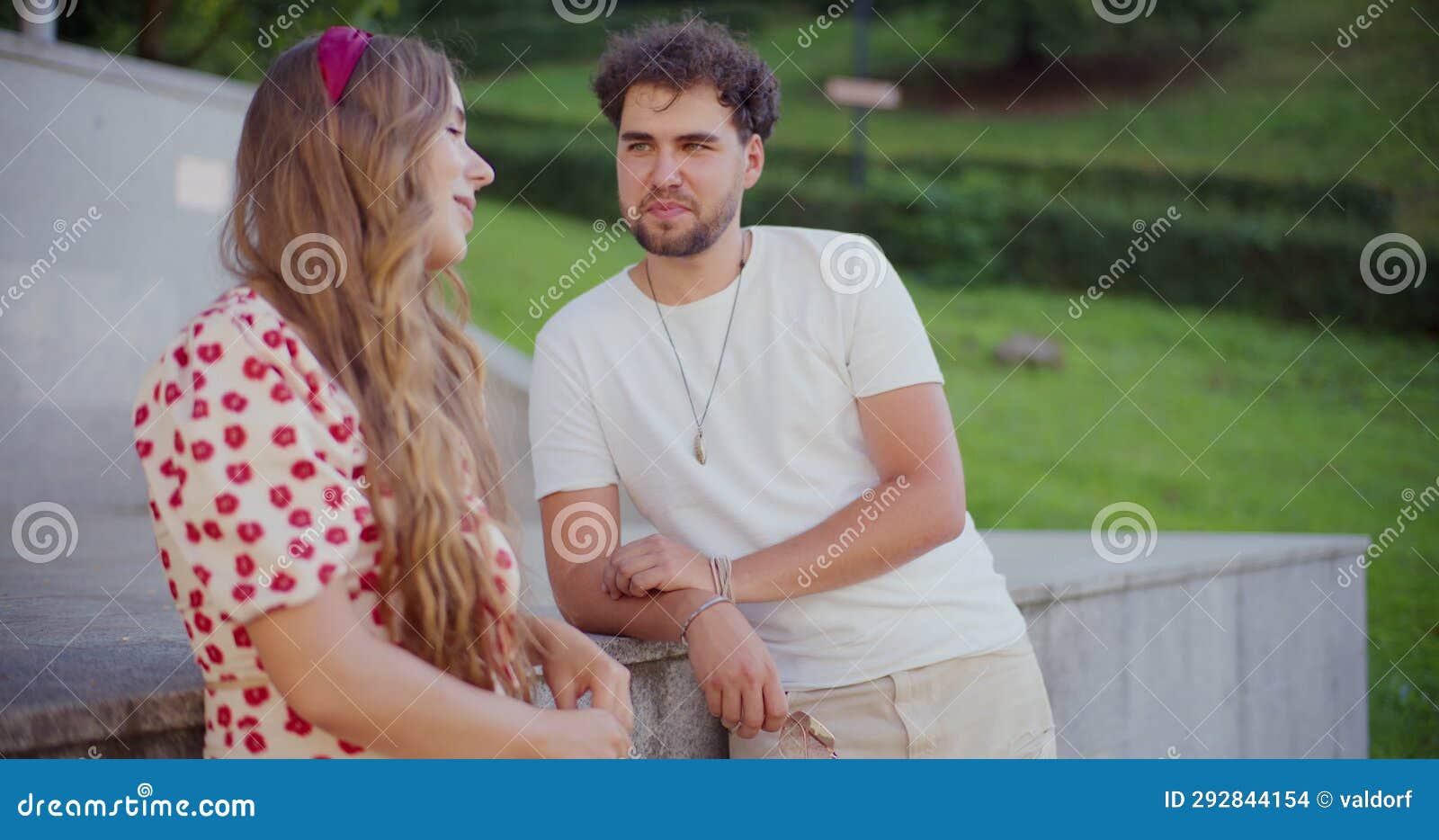 Man Talking with Girlfriend while Leaning on Retaining Wall Stock ...