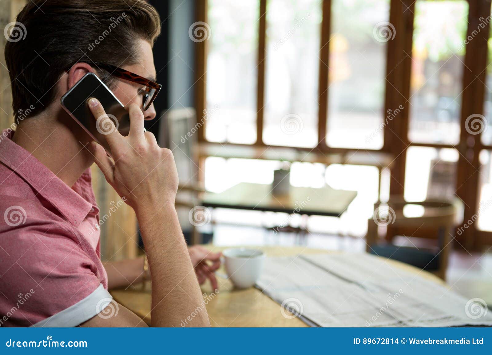 Man Talking on Mobile Phone in Coffee Shop Stock Photo - Image of ...