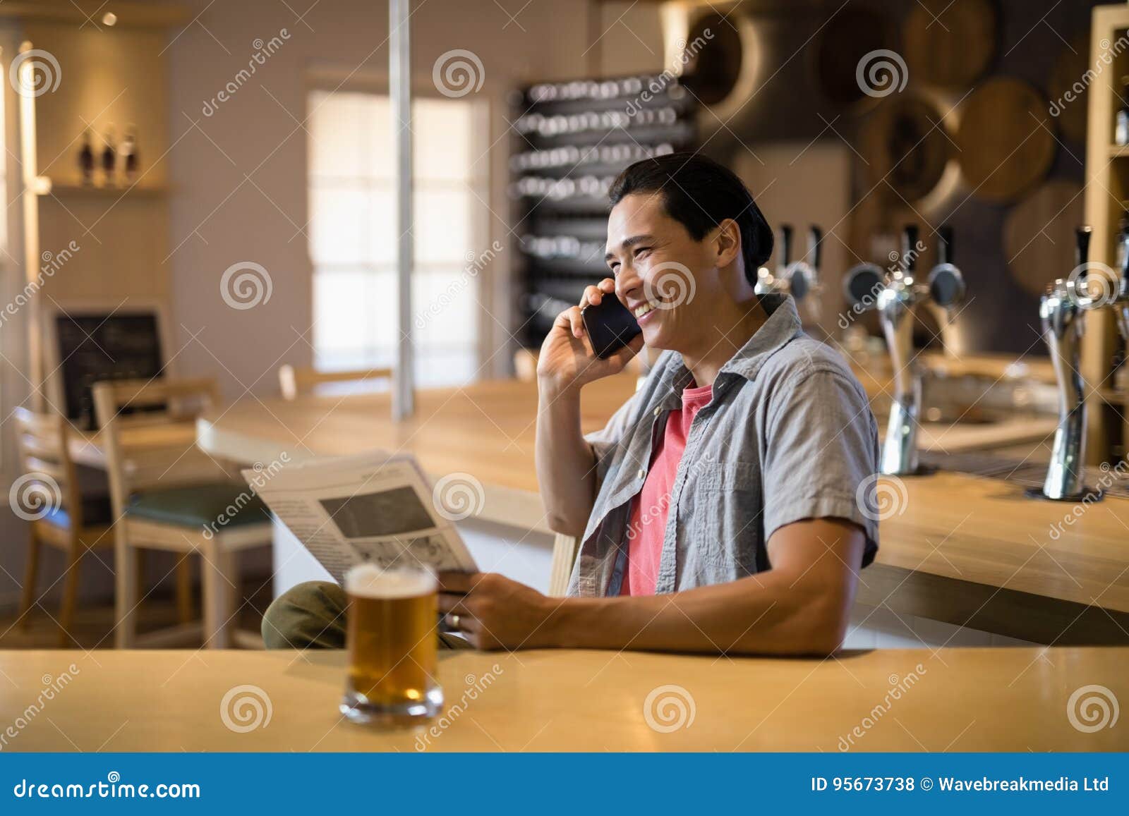 Man Talking on Mobile Phone in a Restaurant Stock Photo - Image of ...