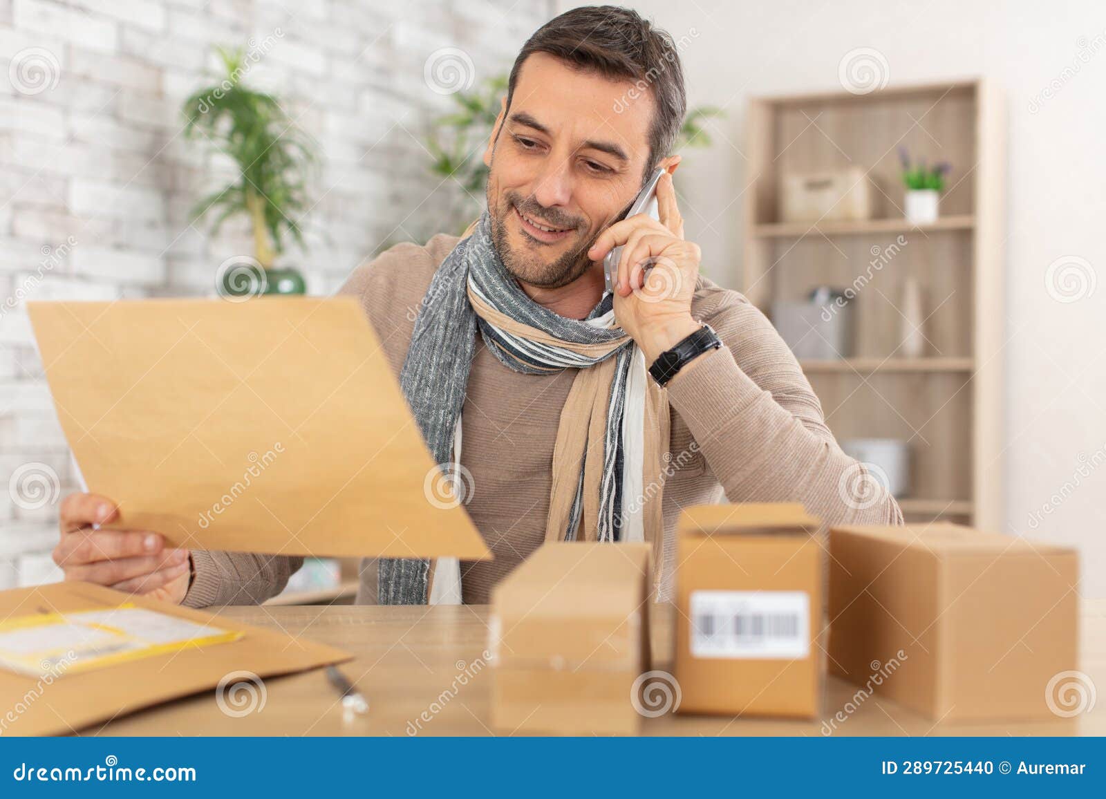 Man Talking on Mobile Phone while Working at Post Office Stock Photo ...