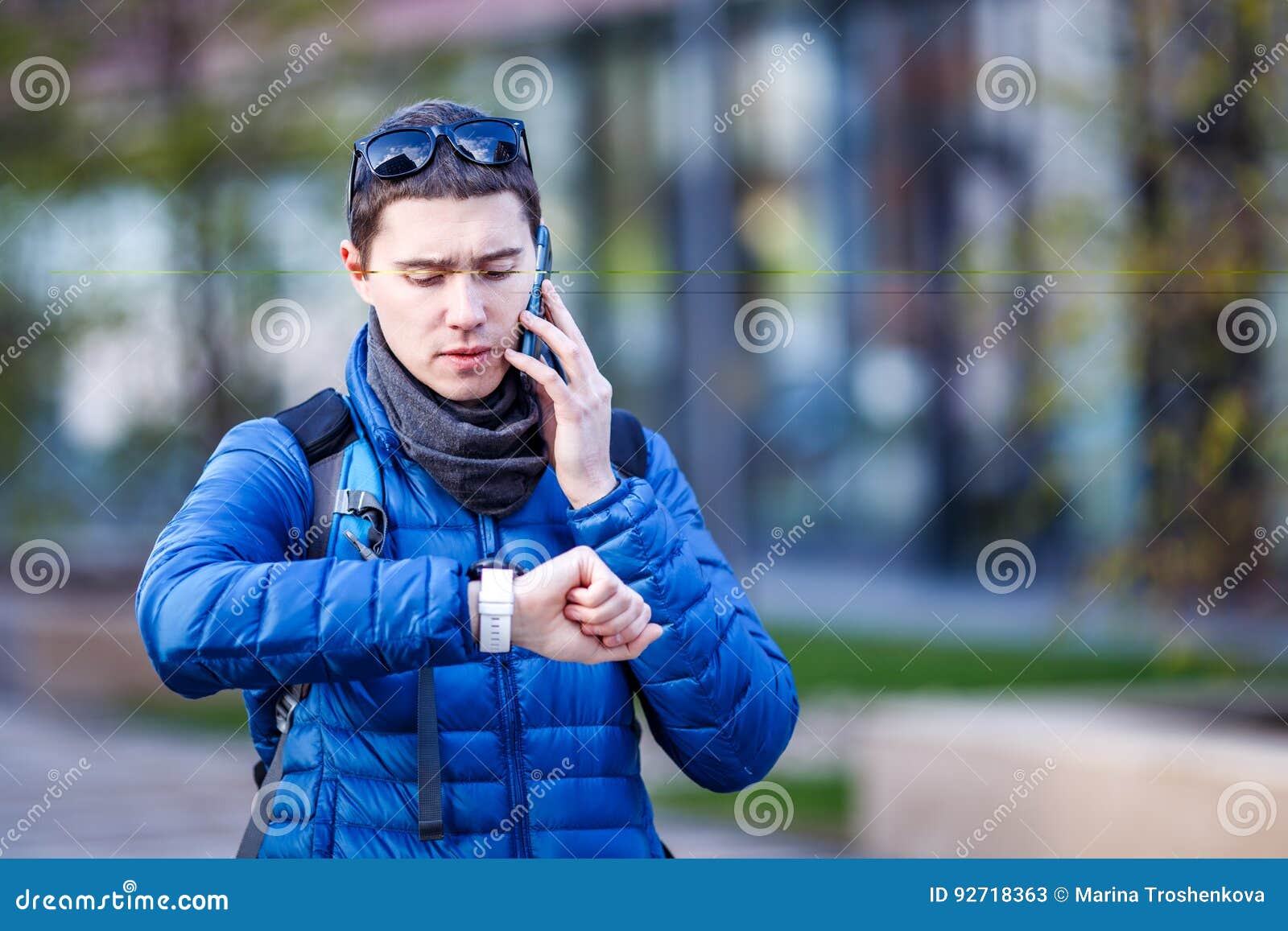 Man Talking on Phone and Looking at Smartwatch Stock Image - Image of ...