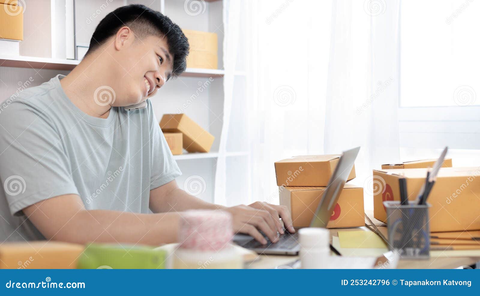 Man Talking on the Phone and Typing on the Computer Chatting with ...