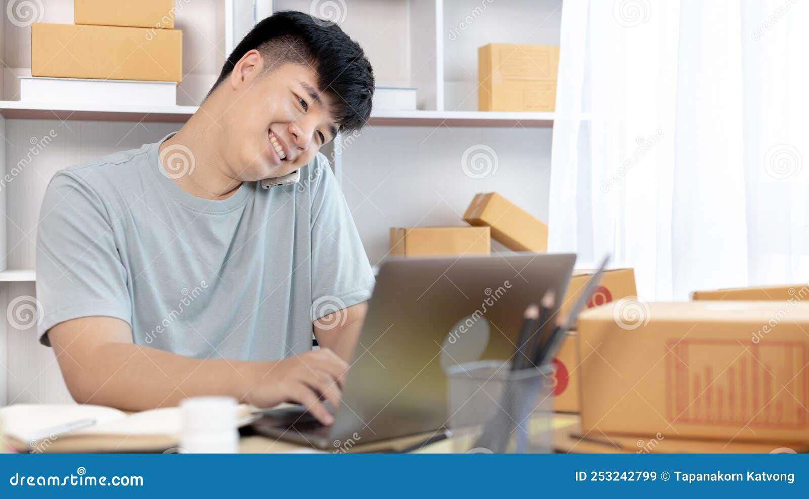 Man Talking on the Phone and Typing on the Computer Chatting with ...