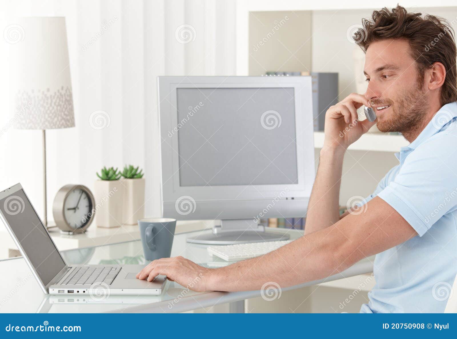 Man Talking on Phone Using Computer Stock Photo - Image of goodlooking ...