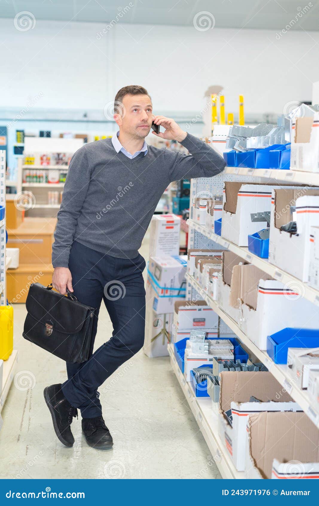Man Talking on Smart Phone in Store Looking Stock Photo - Image of ...