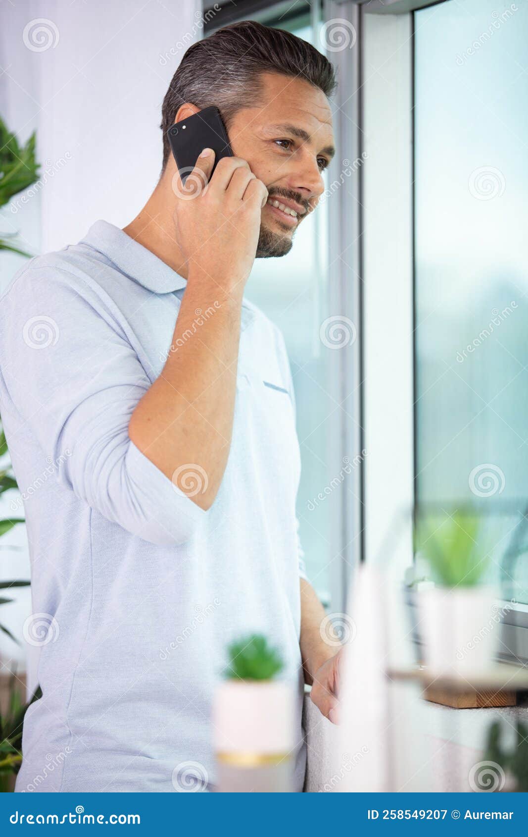 Man Talking on Smartphone Stood by Window Stock Image - Image of ...