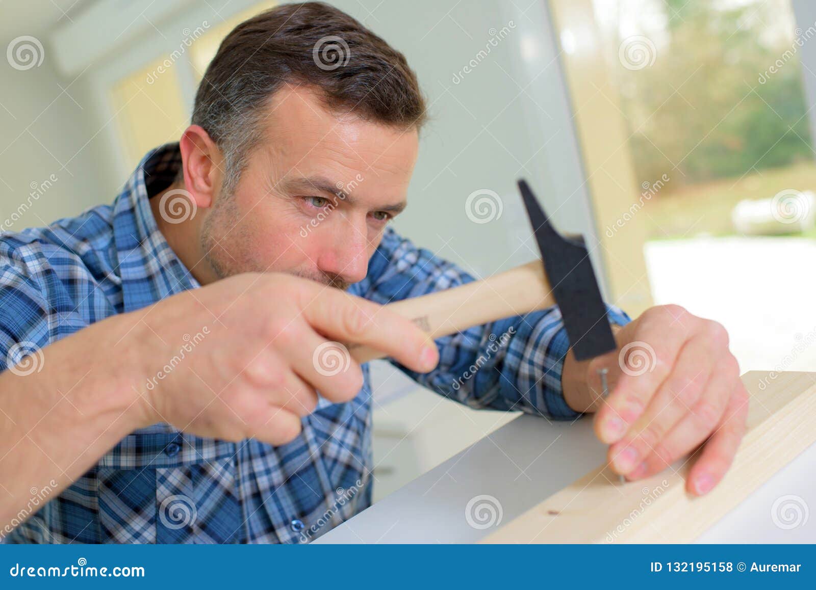 Man tapping nail into wood stock photo. Image of carpenter - 132195158