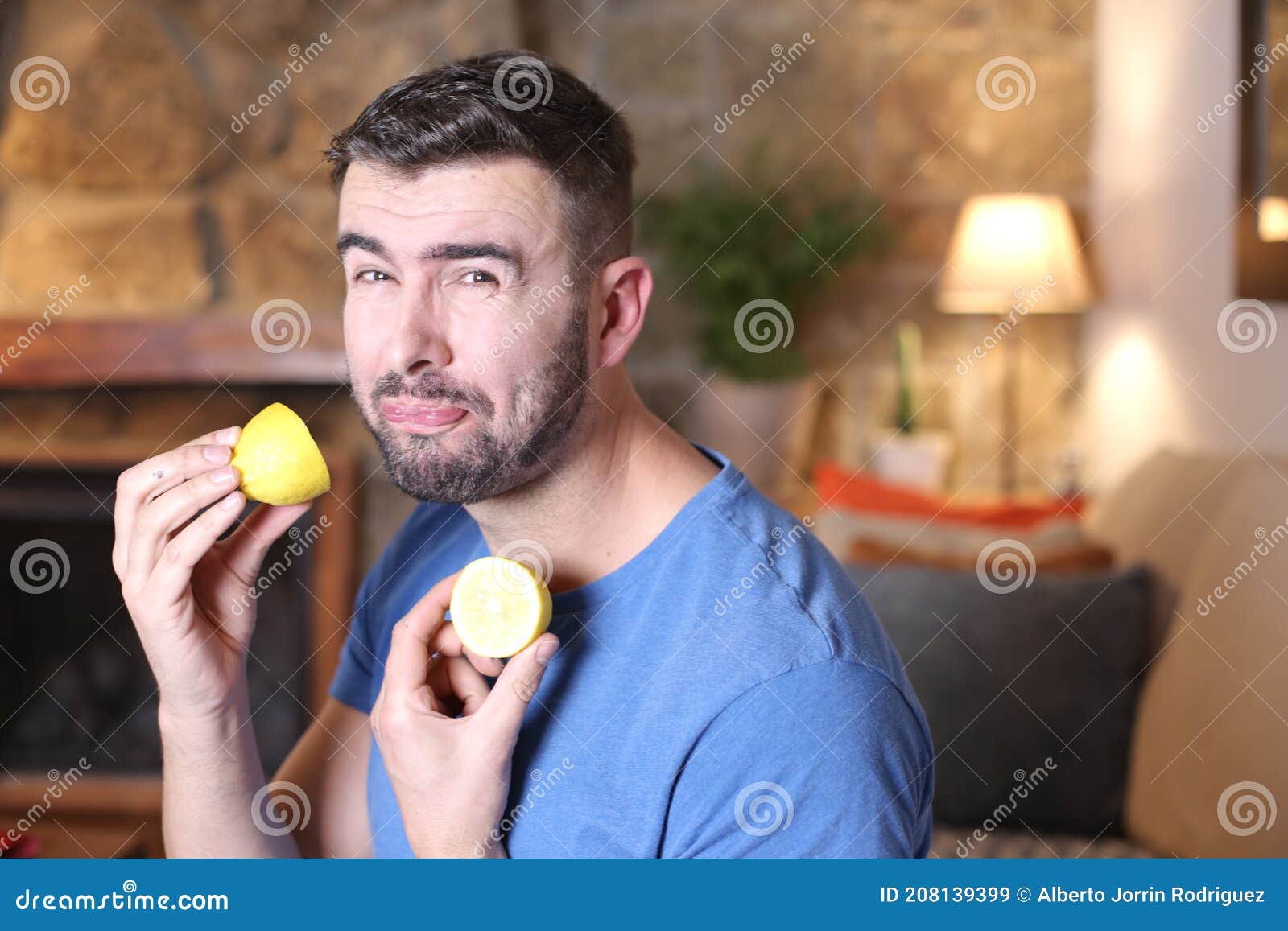 Man tasting a raw lemon stock image. Image of adult - 208139399