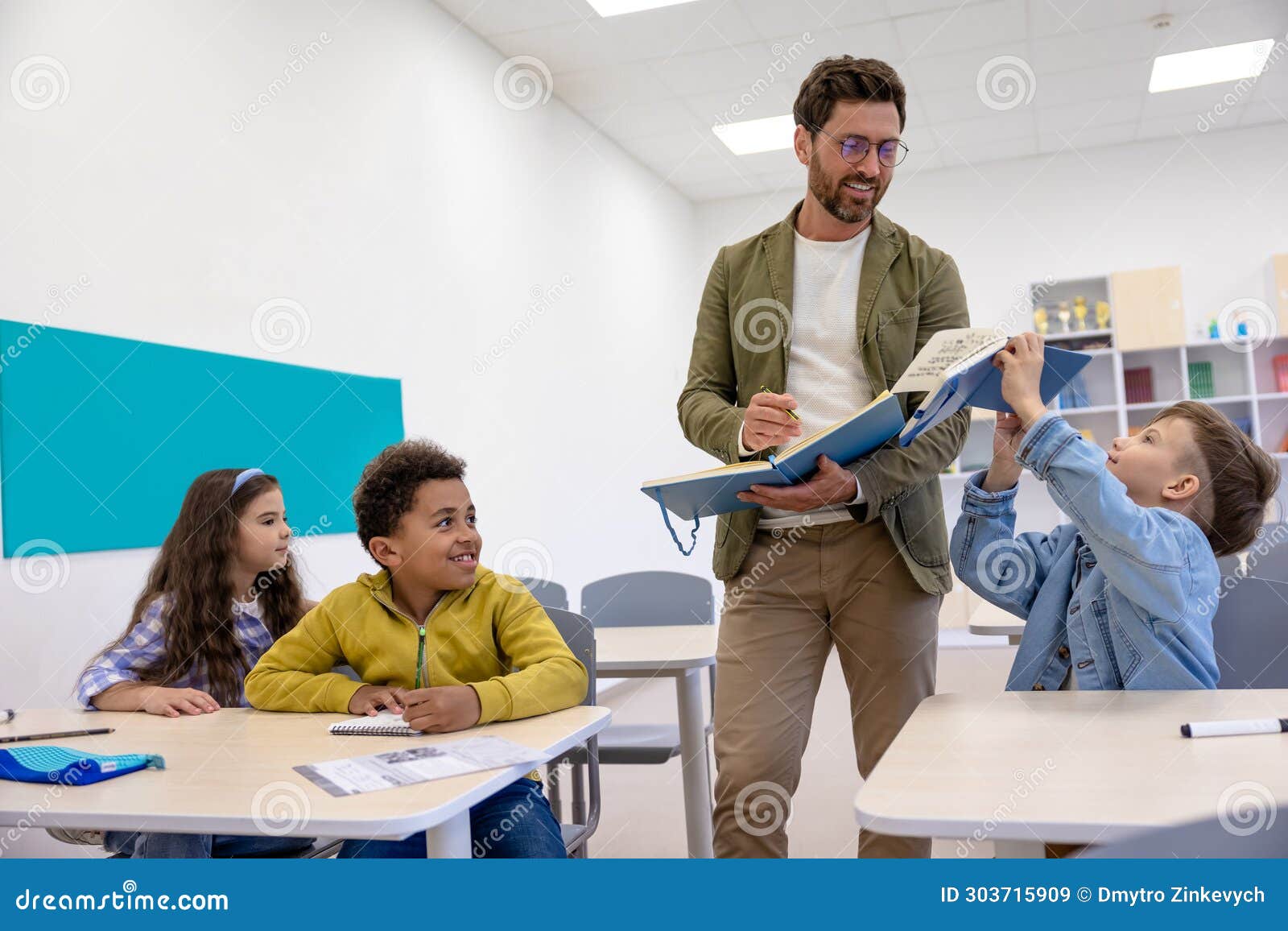 Man Teacher in Classroom with Little Students. Stock Image - Image of ...