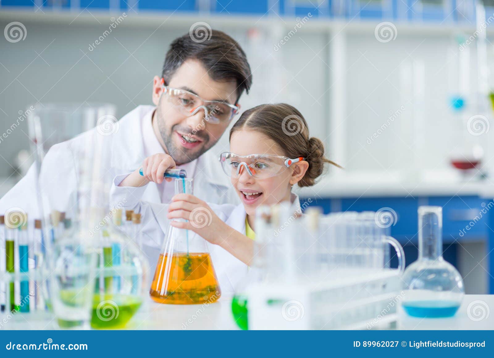 Man Teacher and Girl Student Scientists in Protective Glasses Making ...