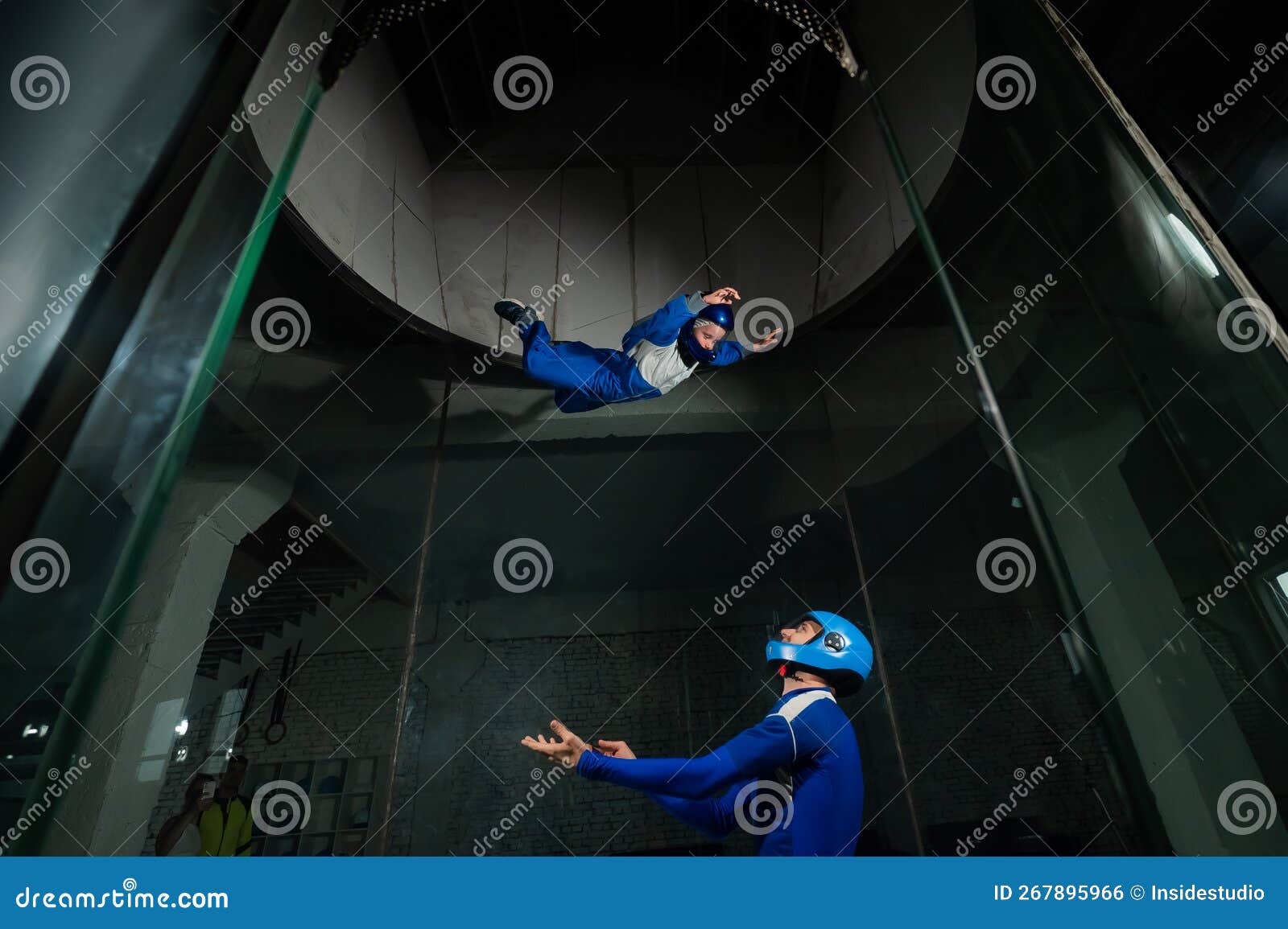 A Man Teaches a Boy To Fly in a Wind Tunnel. Lack of Gravity. Stock ...