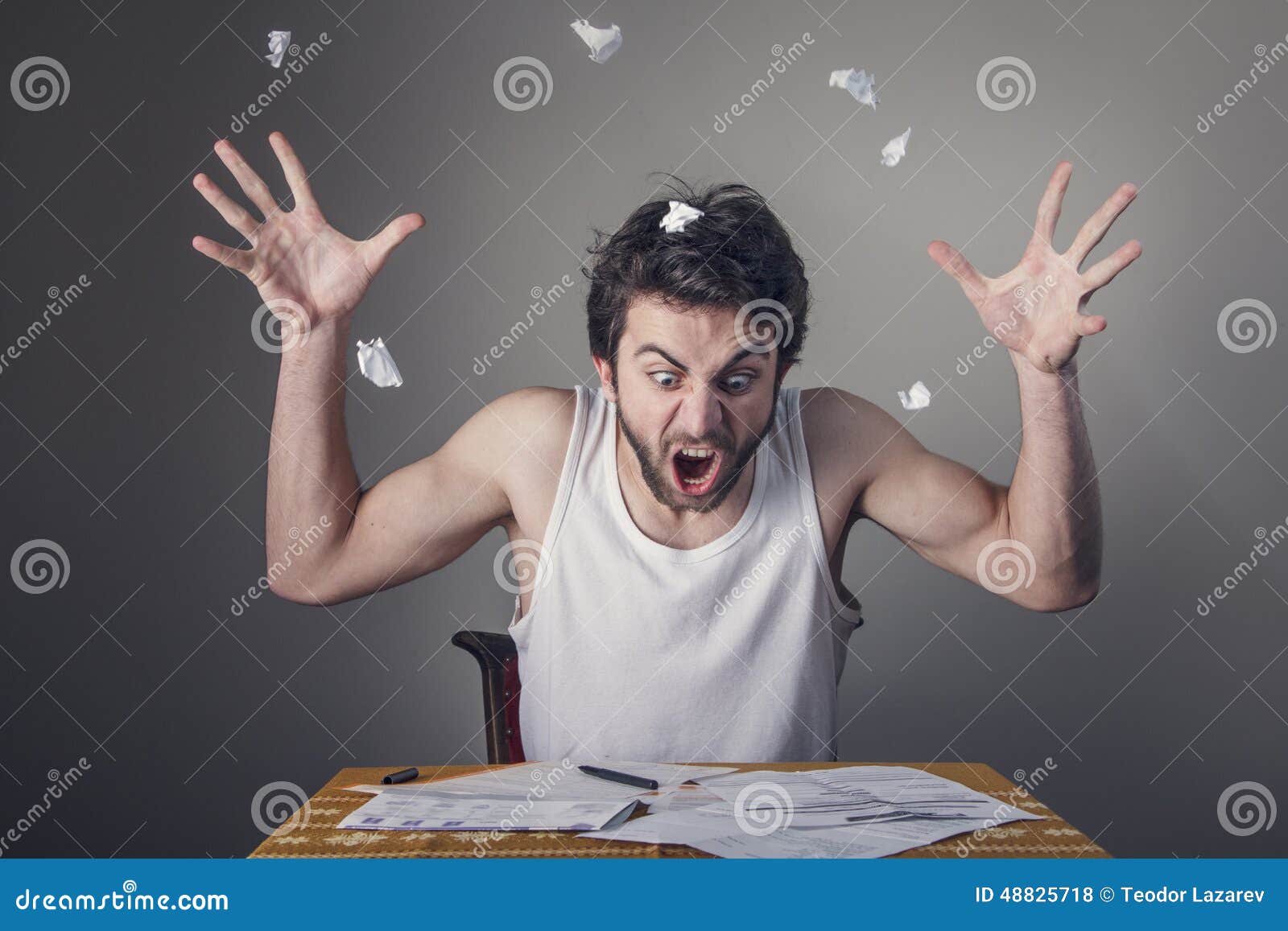 Man tearing apart bills stock photo. Image of finances - 48825718